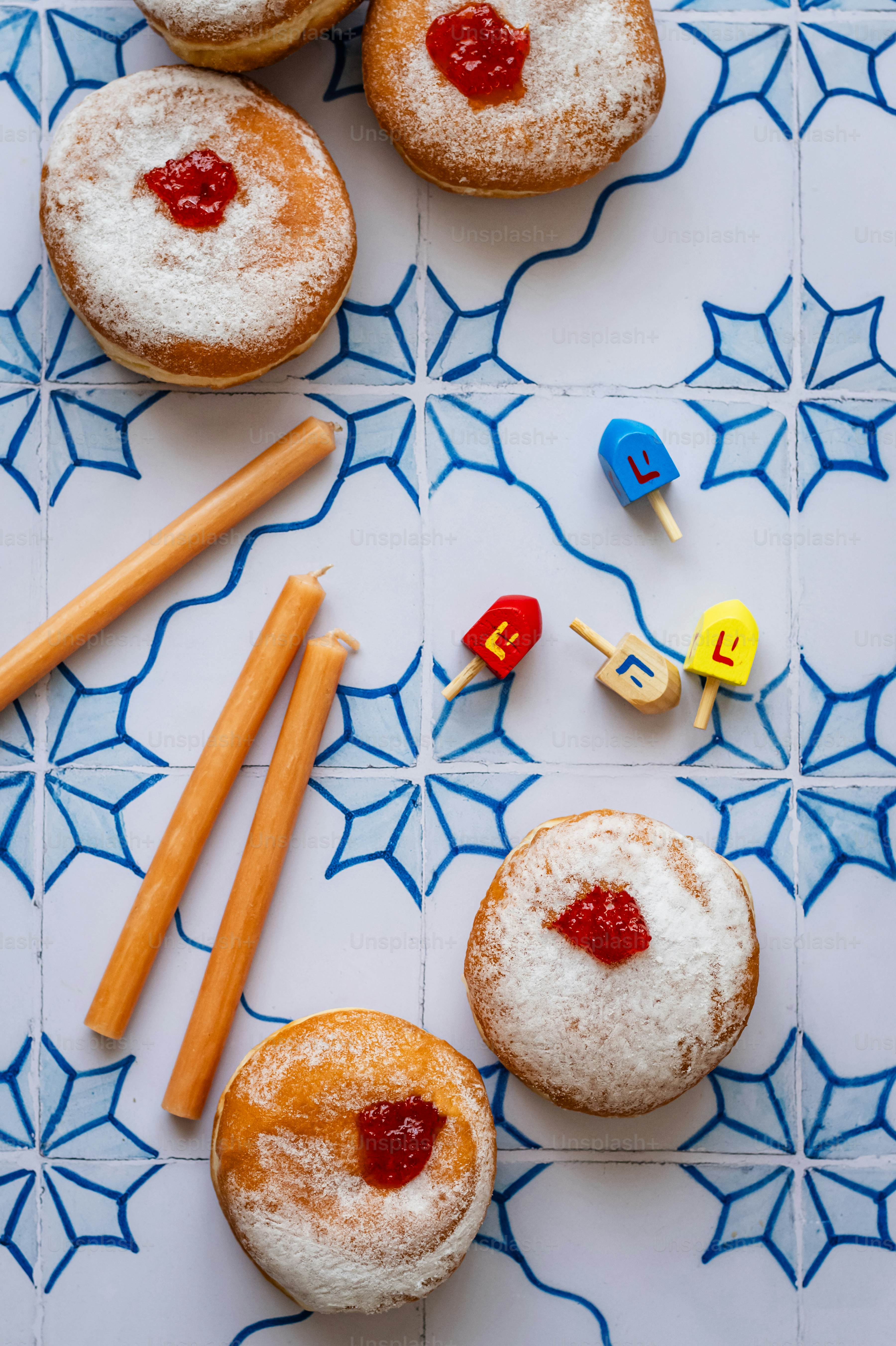 A table topped with pastries covered in powdered sugar photo – Hanukkah ...