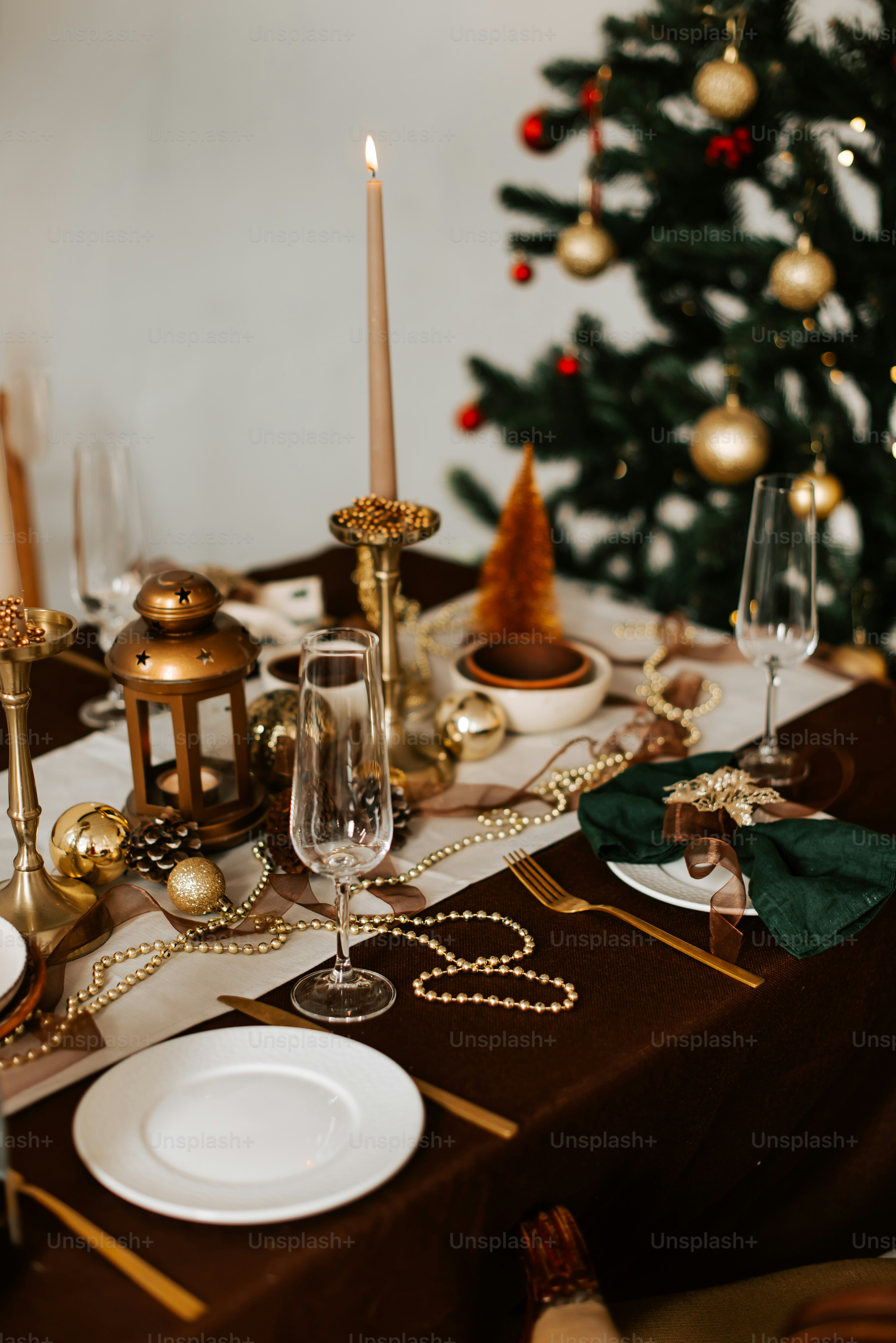 A table with a christmas tree in the background photo – Christmas Image ...
