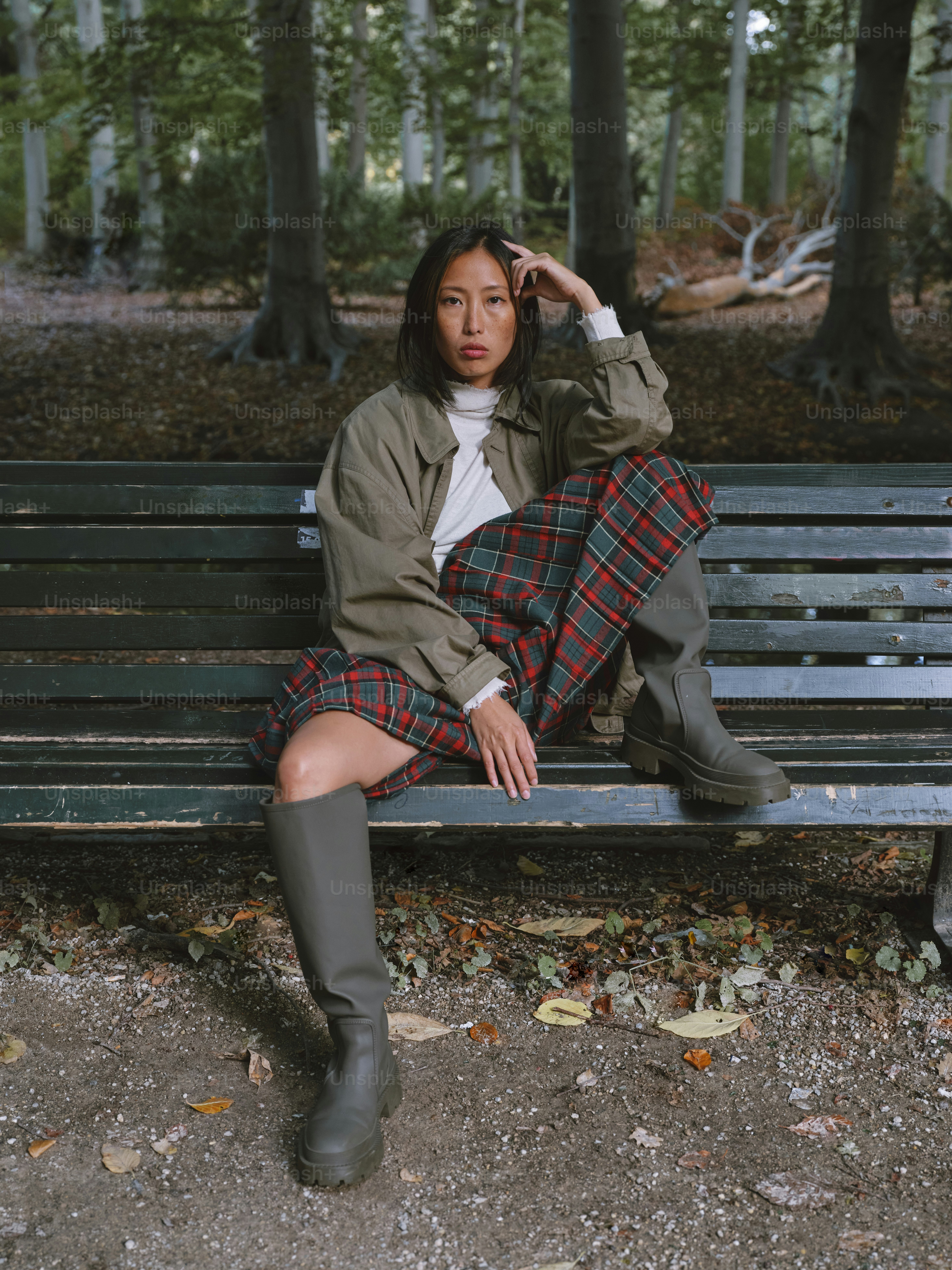 A woman standing on a bench in a forest photo – Autumn Image on Unsplash