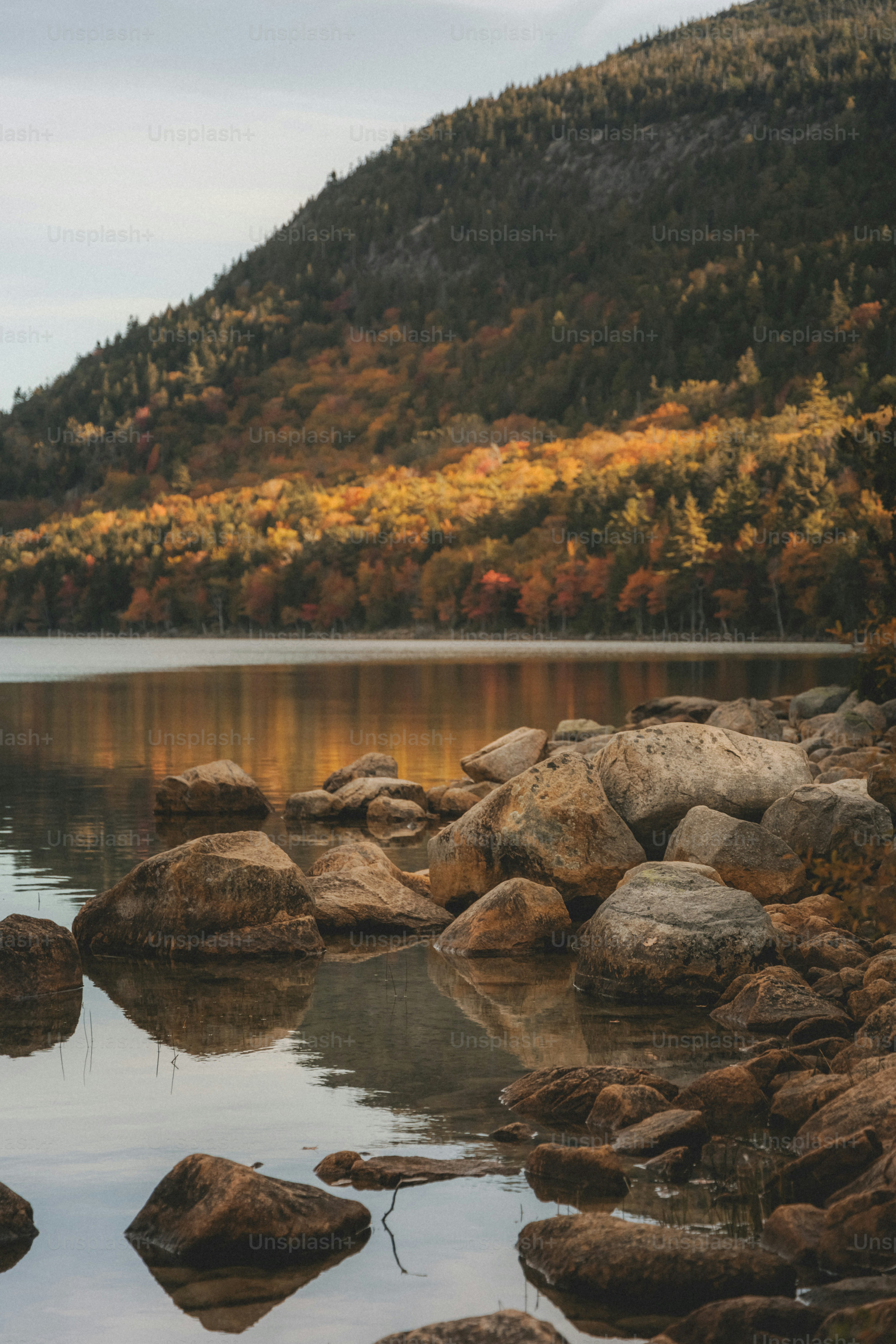 A large body of water surrounded by rocks photo – Nature Image on Unsplash
