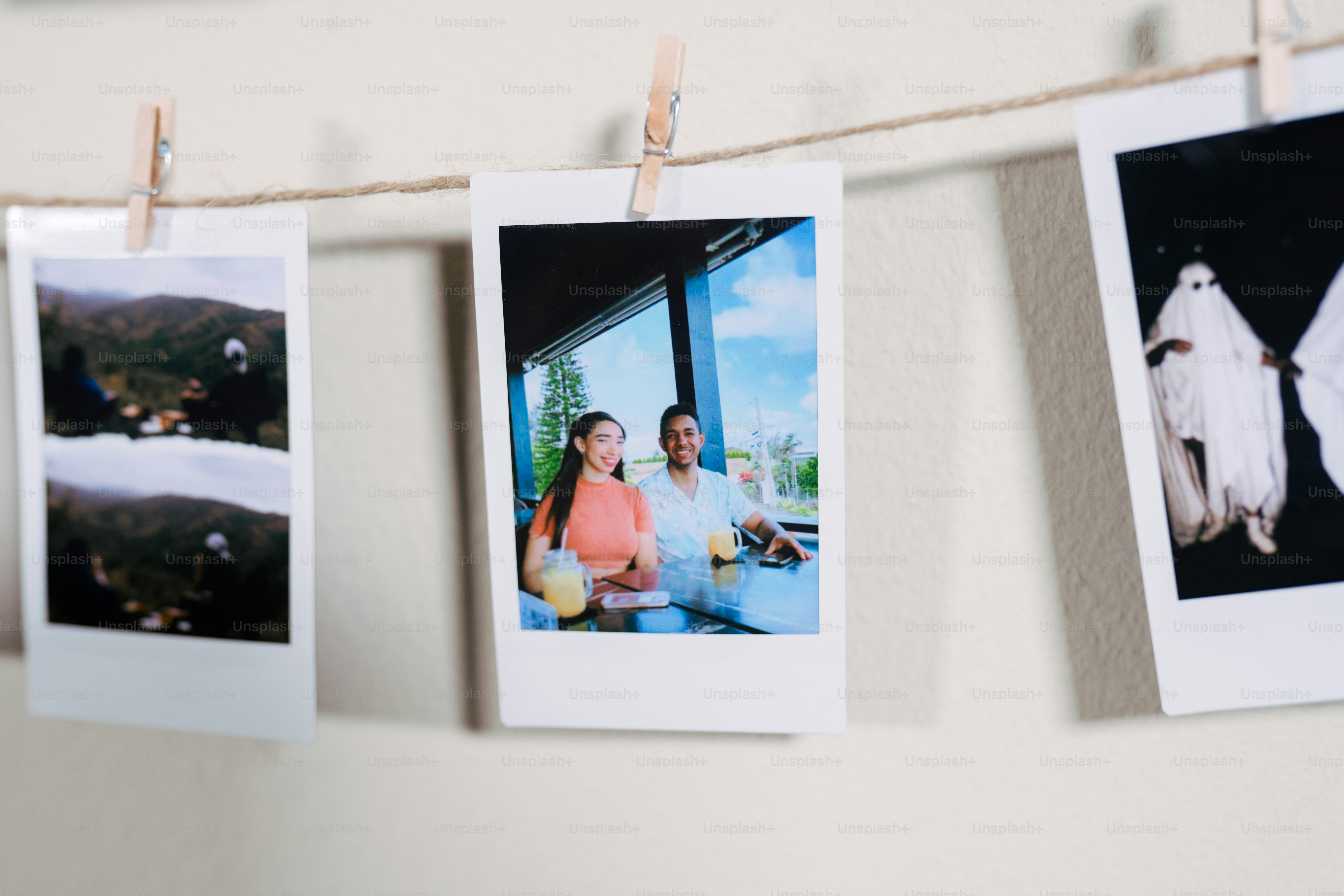 A couple of pictures hanging on a clothes line photo – Polaroid Image ...