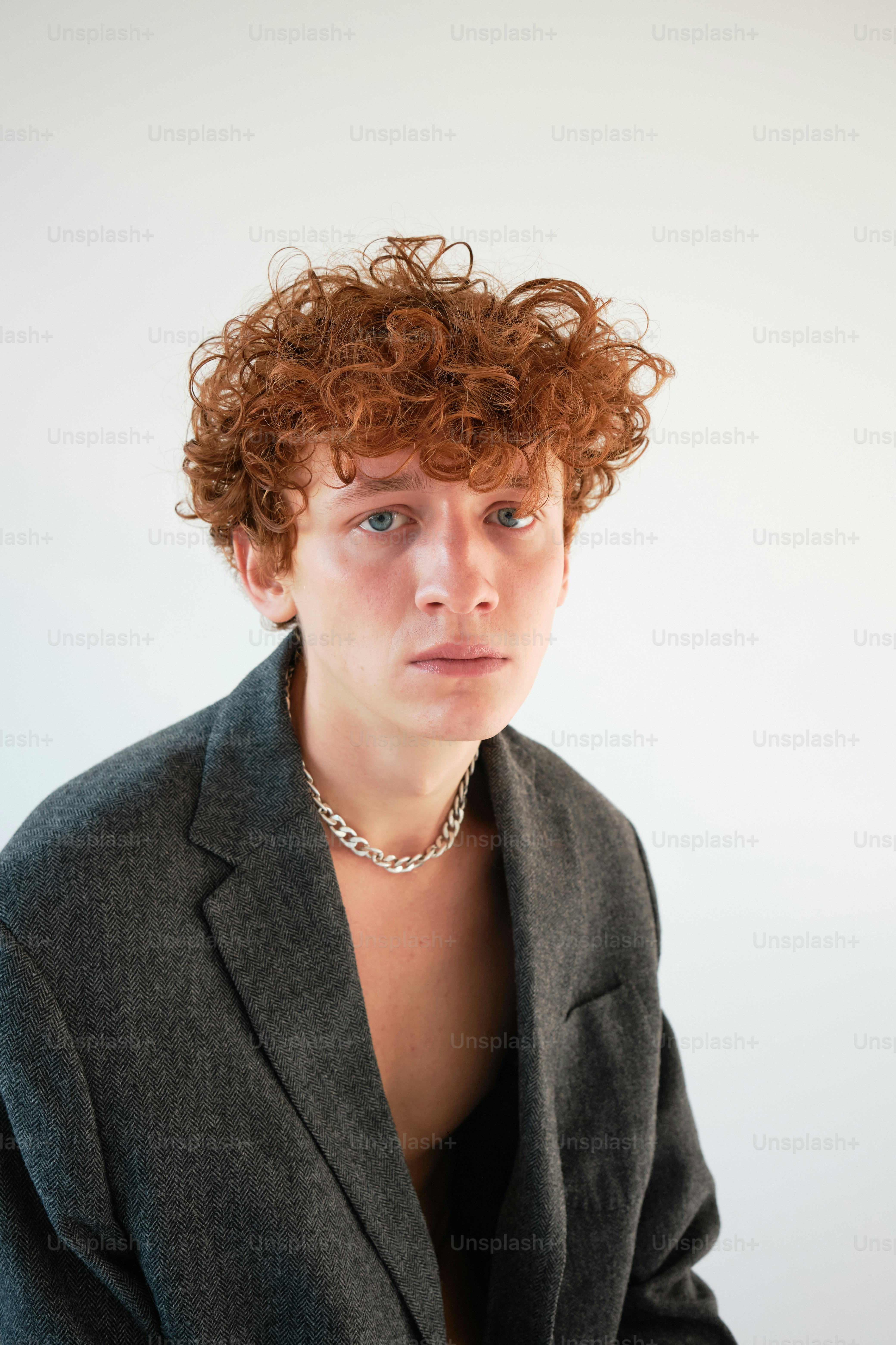 A woman with curly red hair wearing a suit photo – Portrait Image on ...