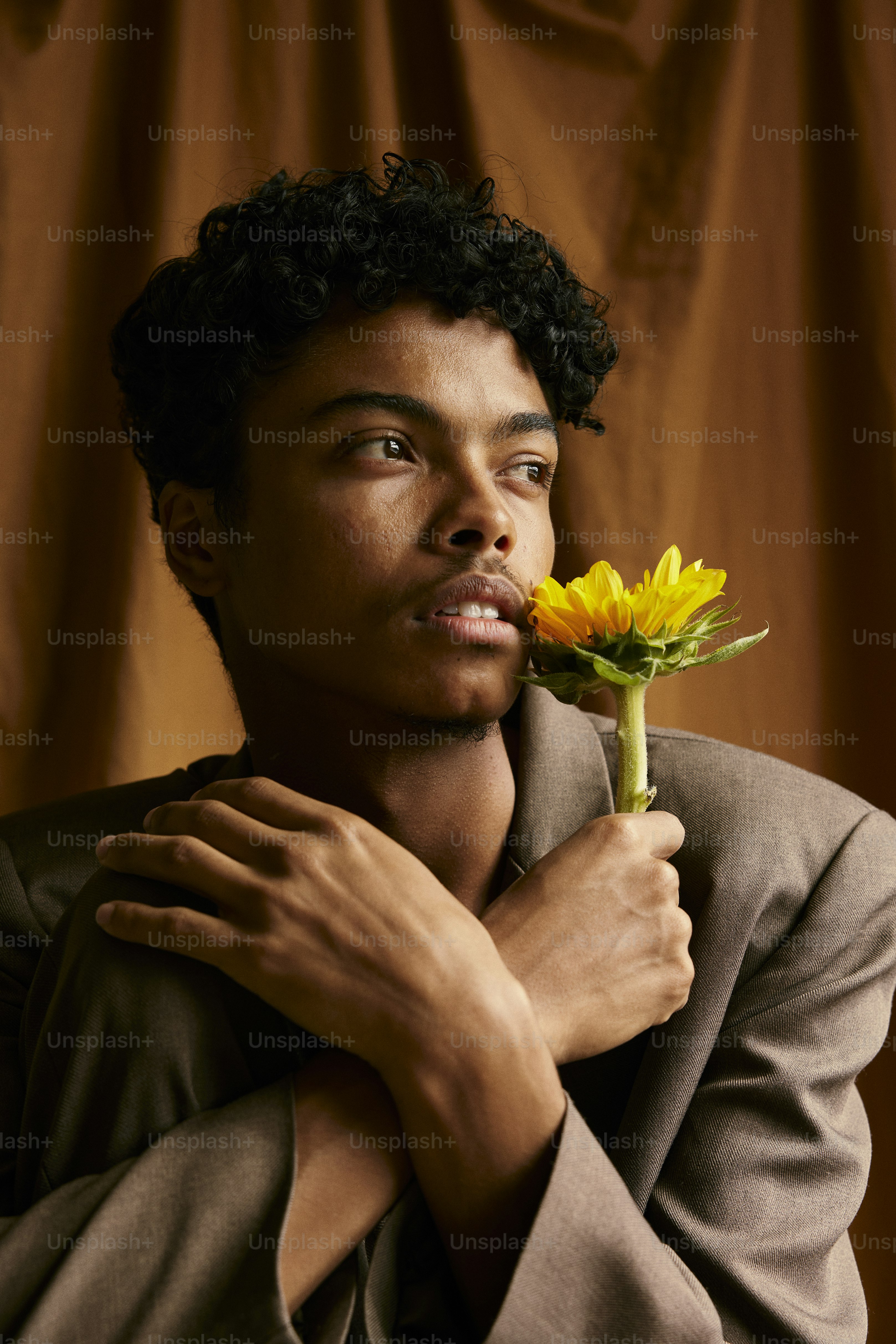 A man with a flower in his hand photo – Male Image on Unsplash