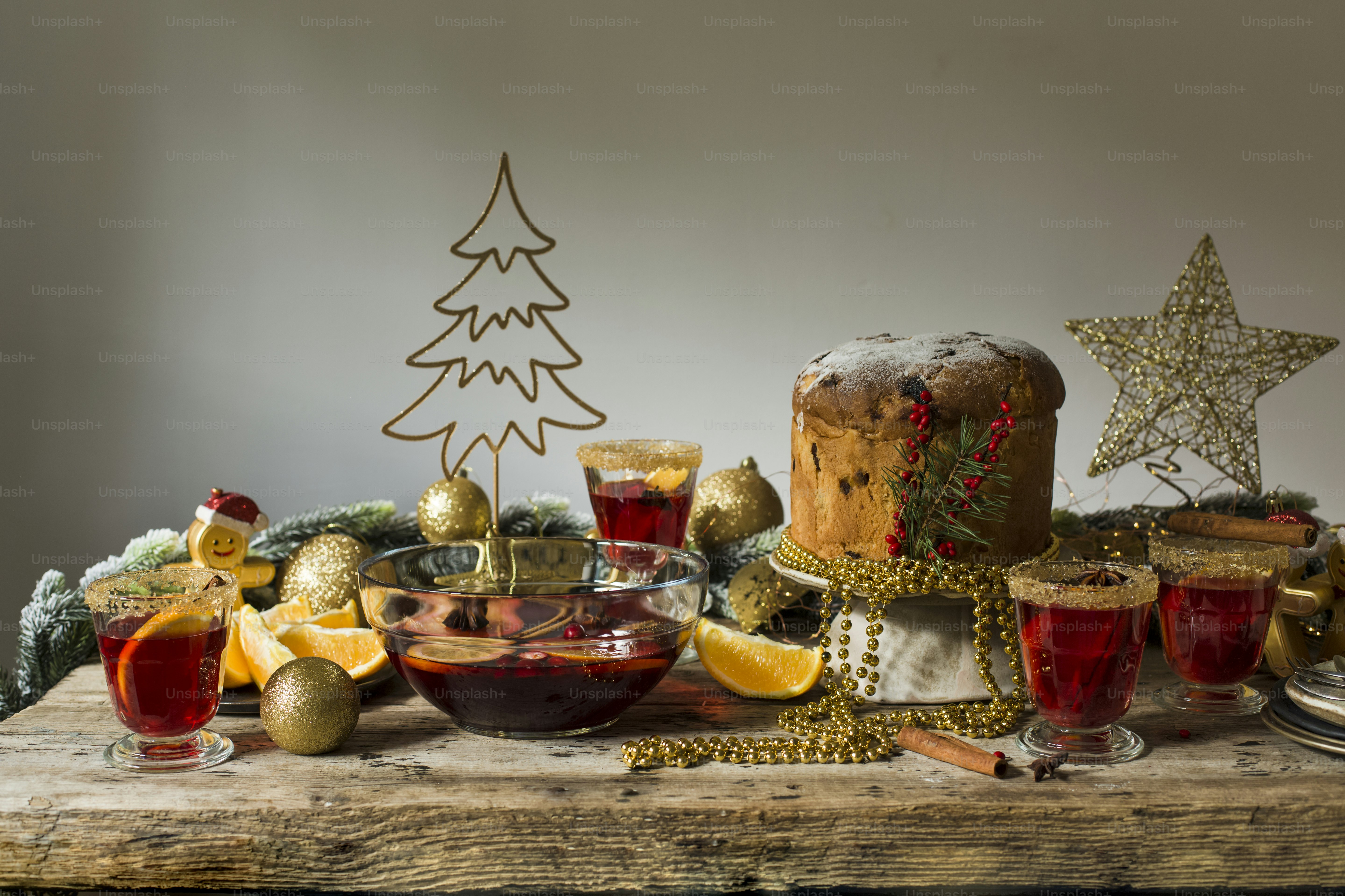 A wooden table topped with a cake next to a bowl of fruit photo ...