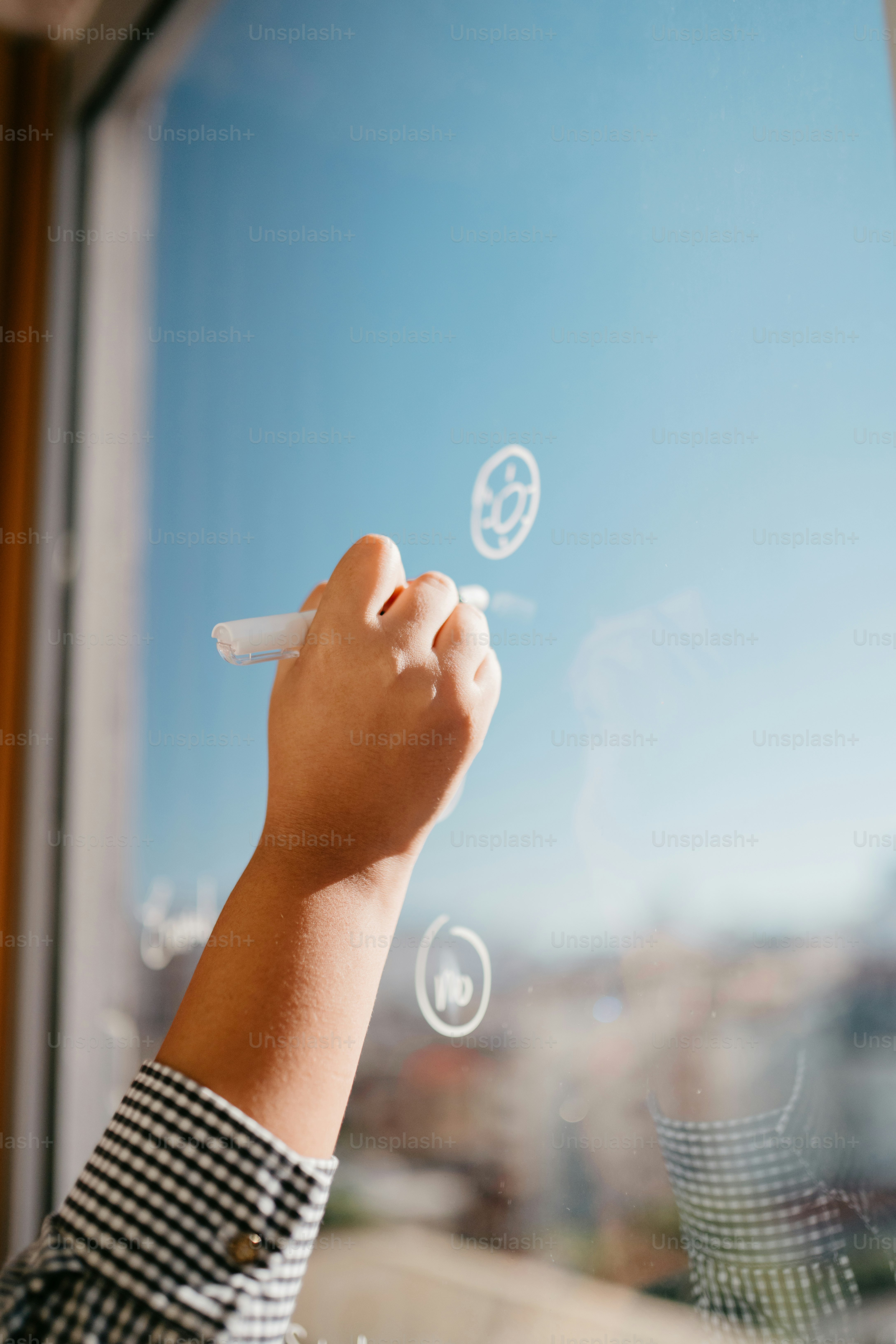 A person writing on a window sill with a marker photo – Equity Image on ...