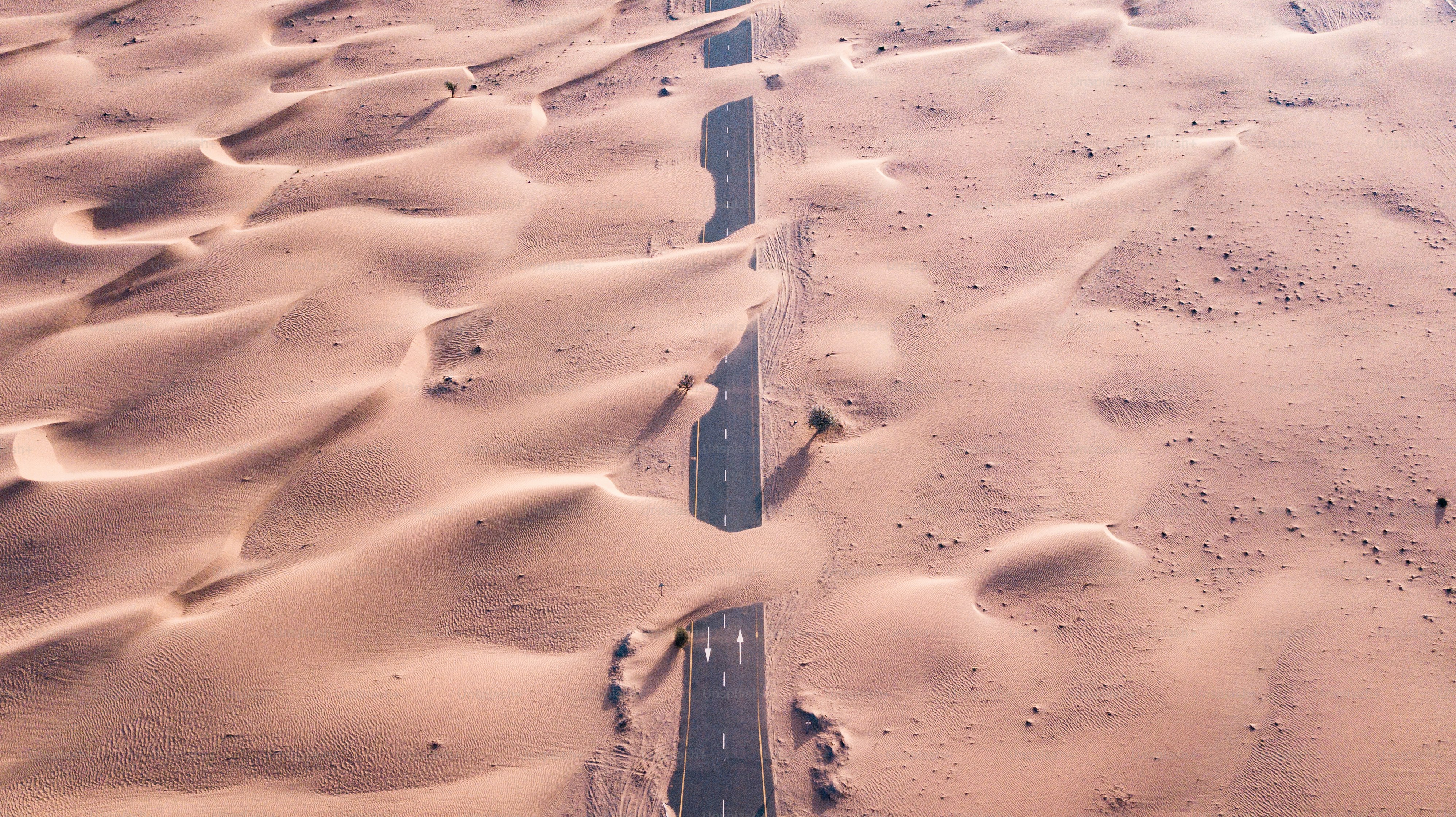 A highway covered by sand after a sandstorm in a desert in UAE photo ...