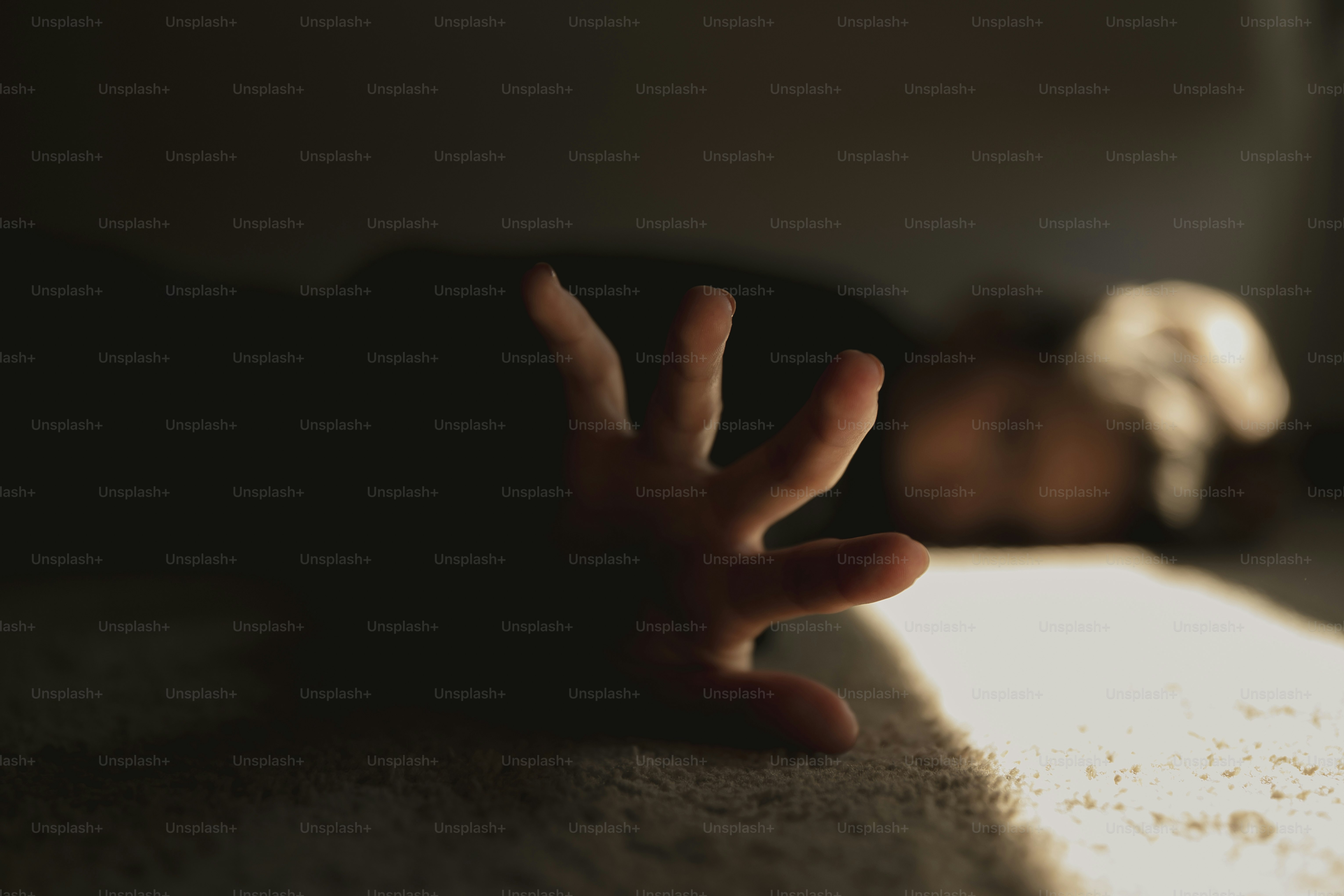 A person laying on the floor with their hand on the floor photo ...