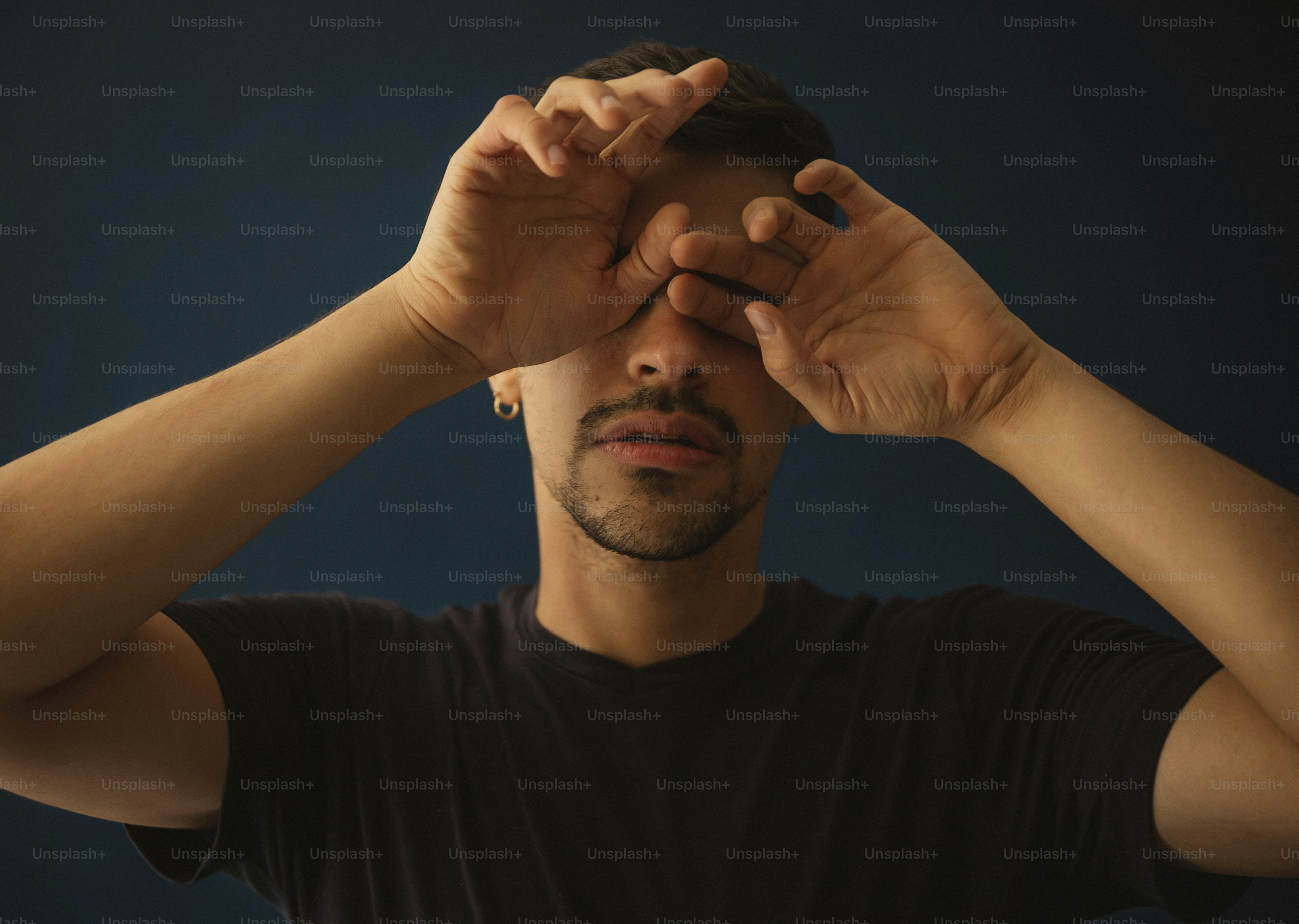 A man holding his hands up to his face photo – Sad mood Image on Unsplash