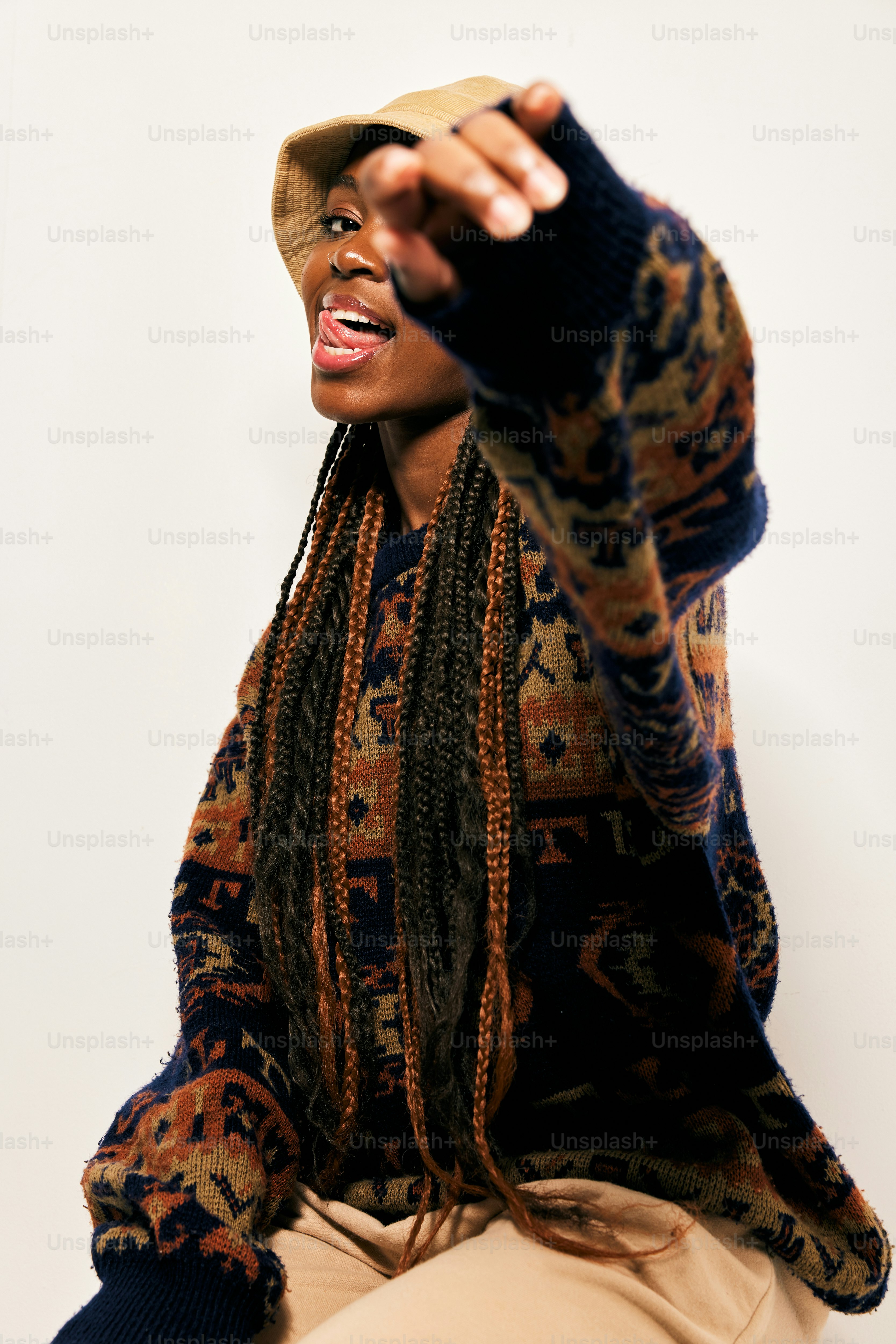 A woman with dreadlocks sitting on the ground photo – Fashion Image on ...