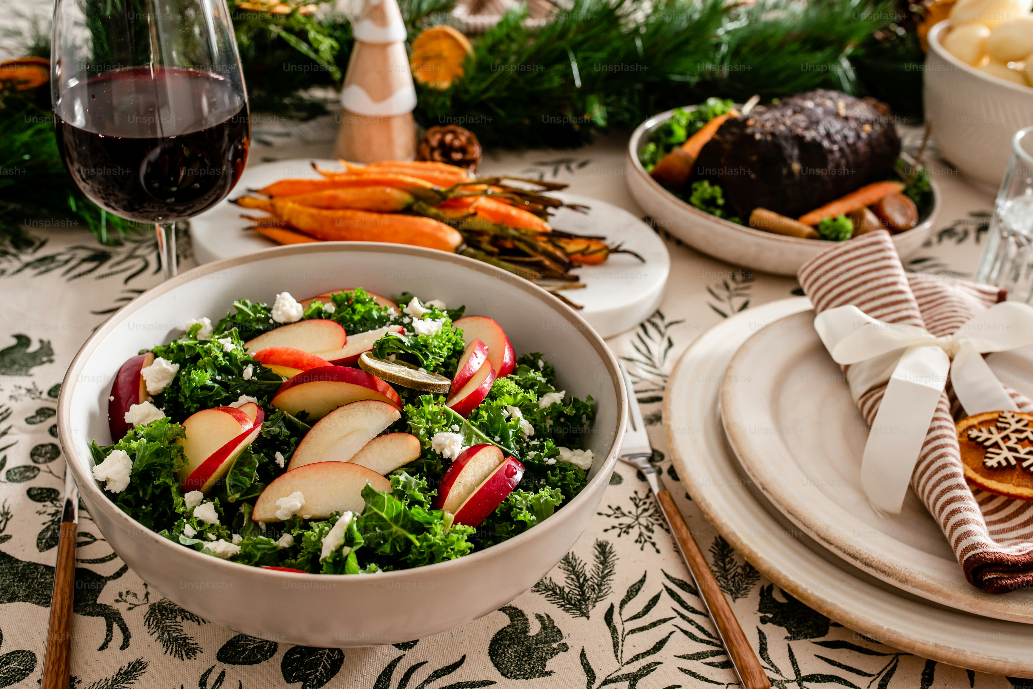 A table topped with plates and bowls filled with food photo – Christmas ...