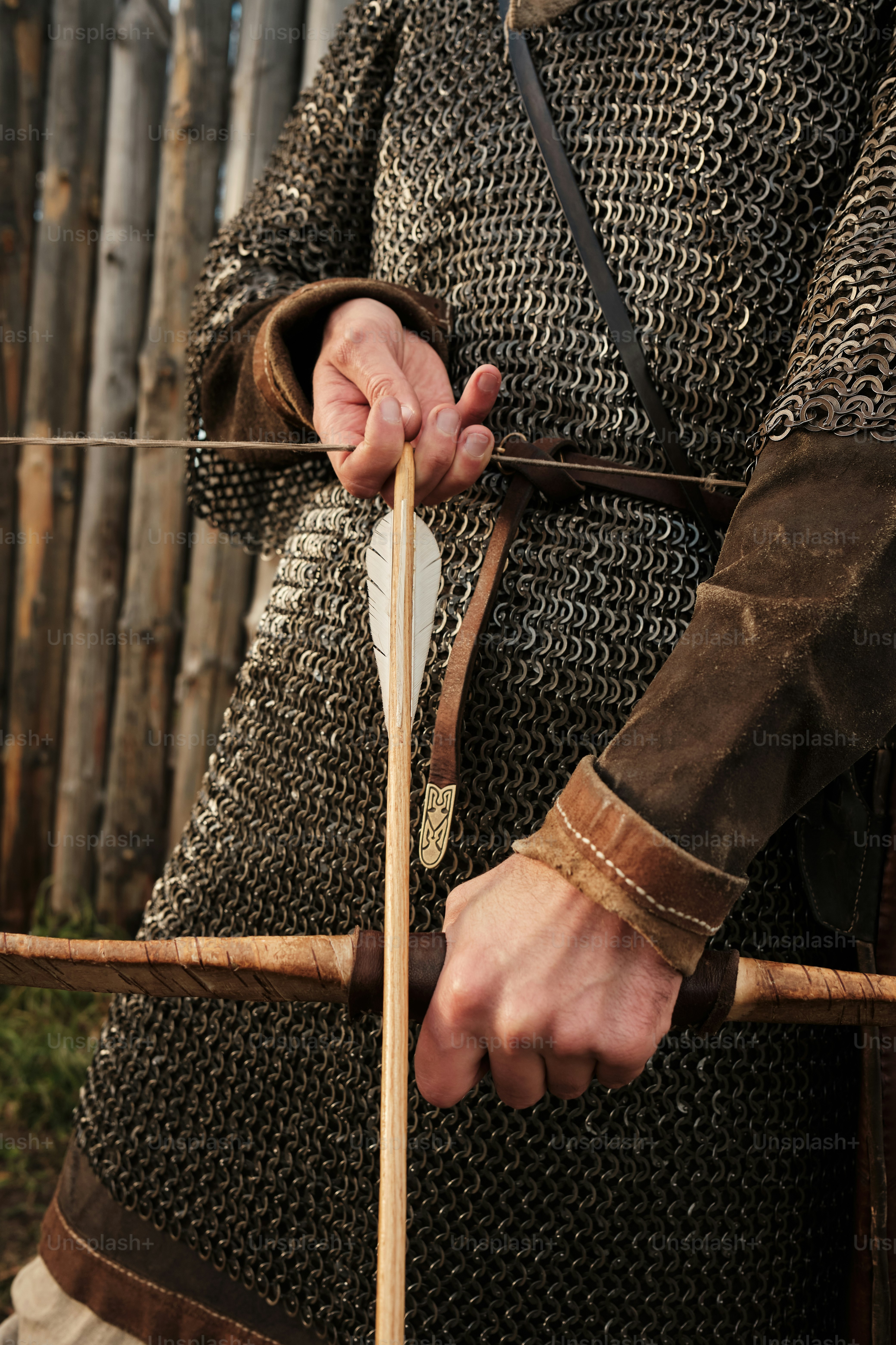 A man dressed as a knight holding a bow and arrow photo – Medieval ...