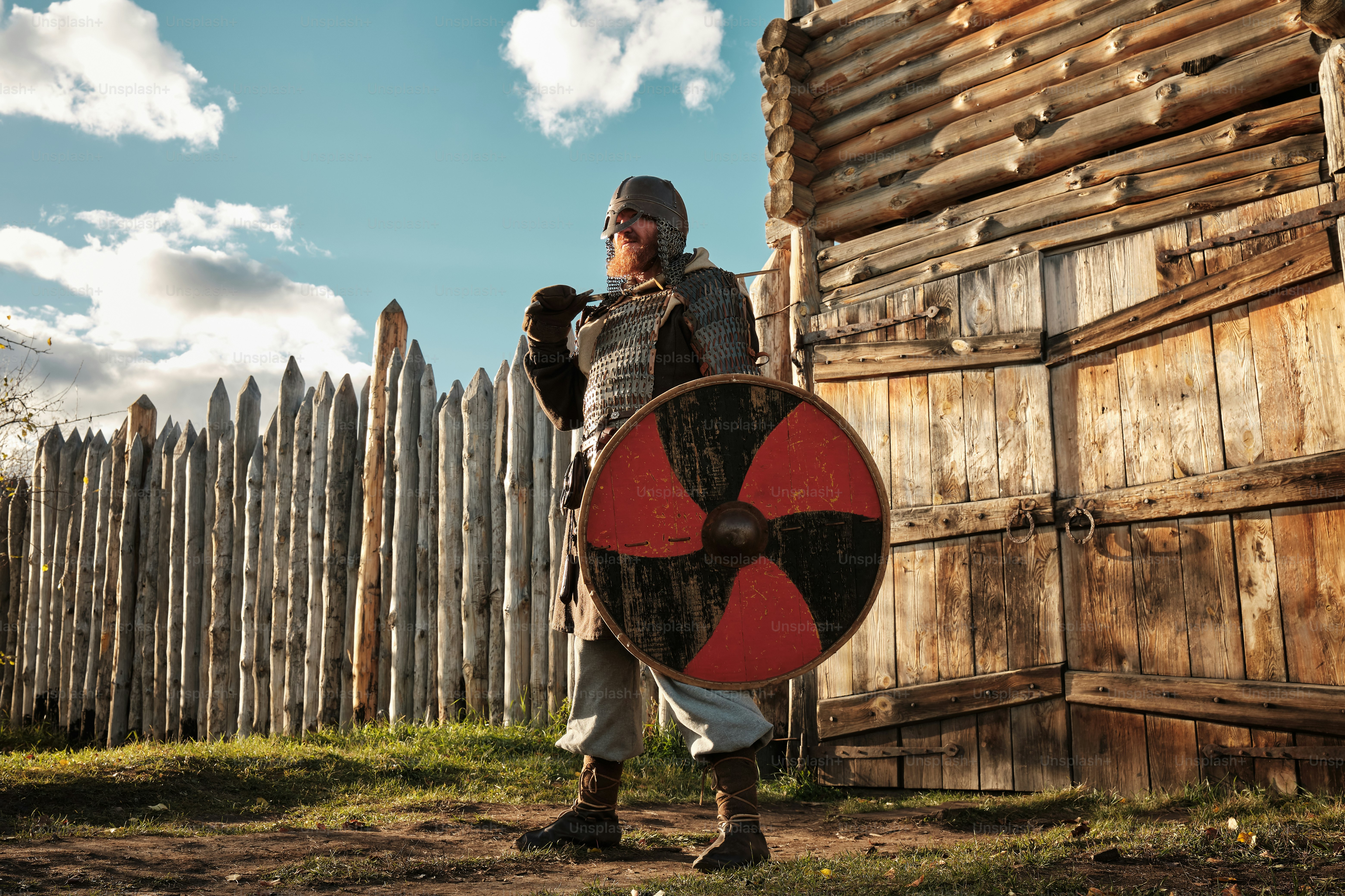 A man holding a large red and black shield photo – Knight Image on Unsplash