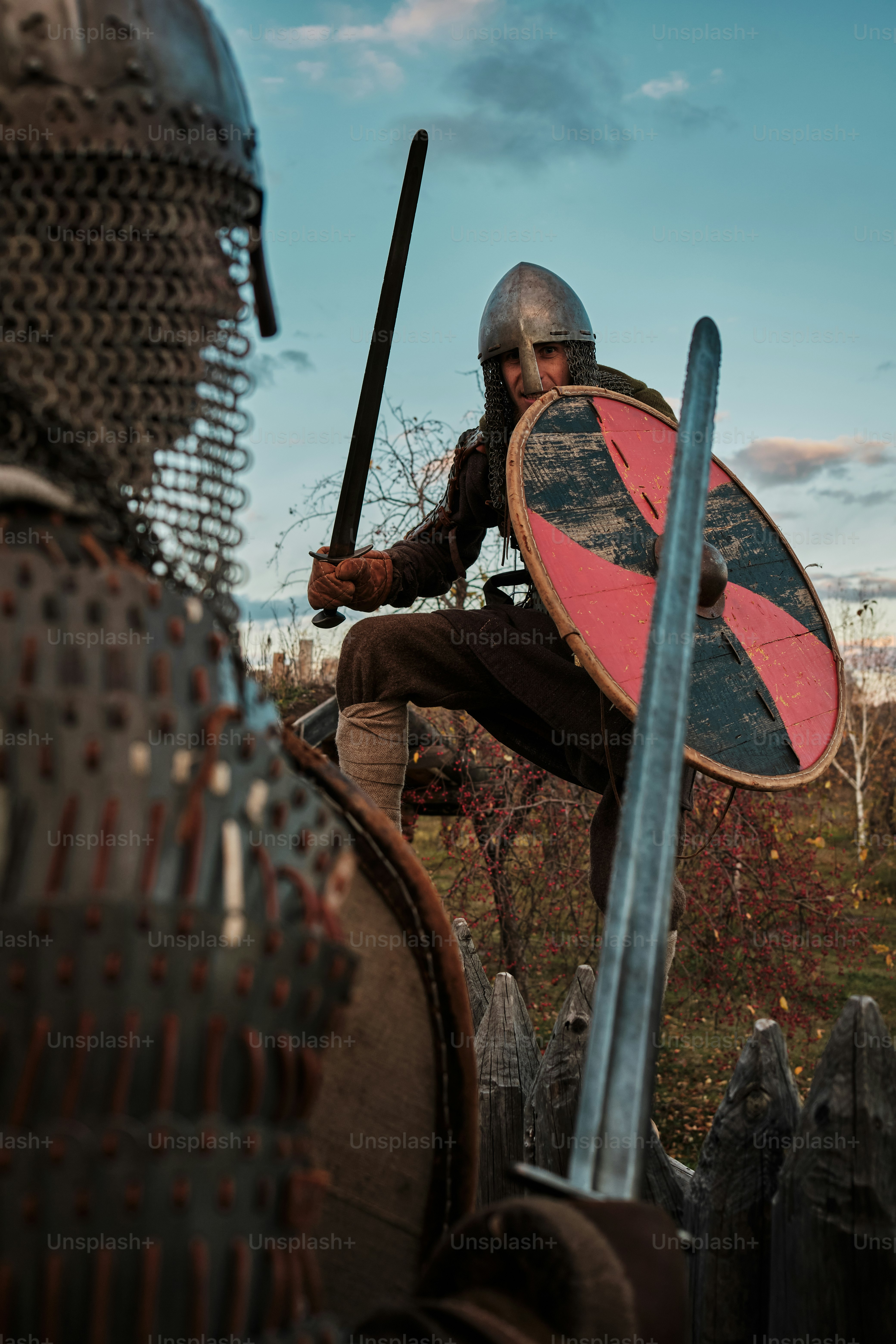 A couple of men in armor standing next to each other photo – Man Image ...