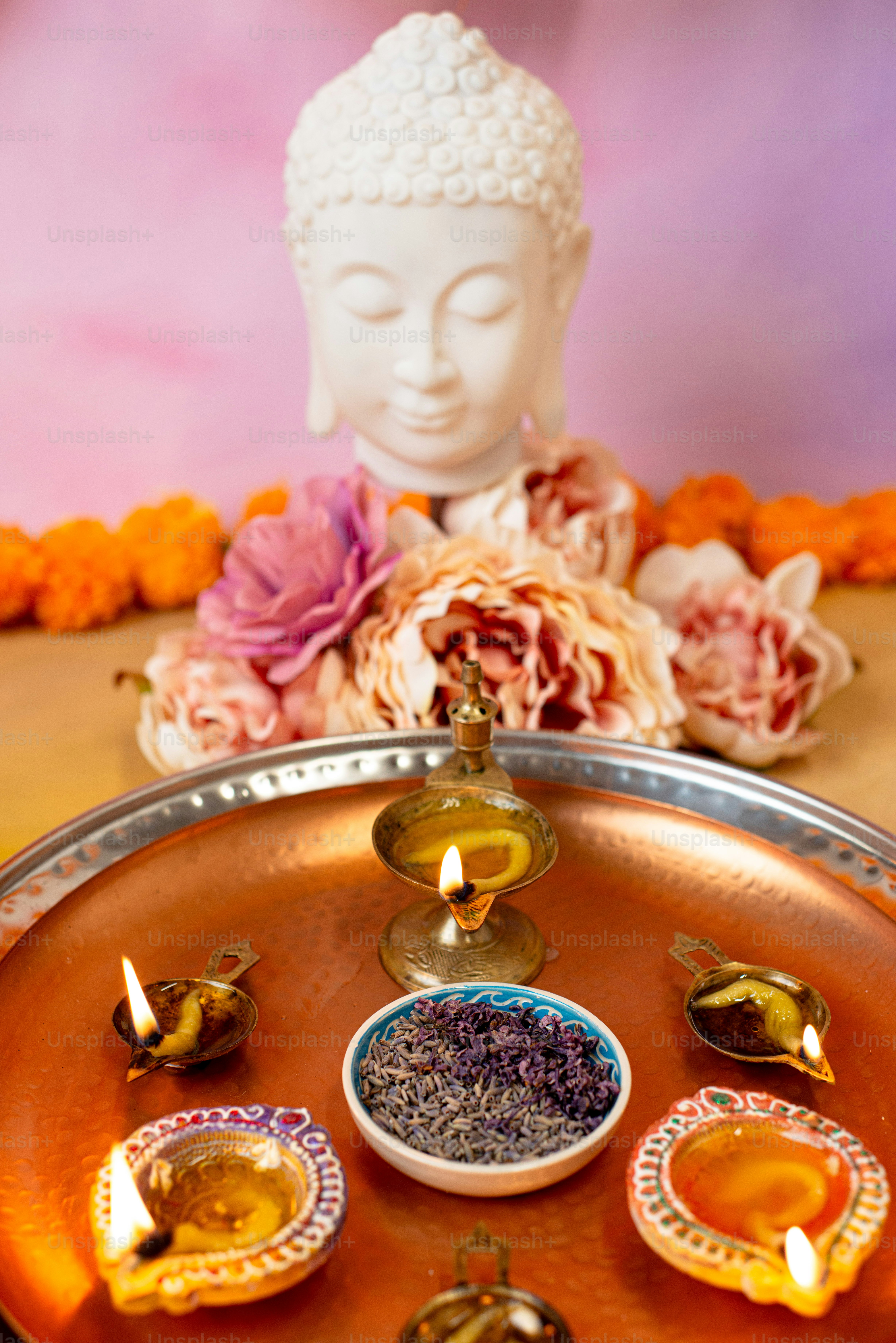 A buddha statue sitting on top of a metal tray photo – Diwali Image on ...
