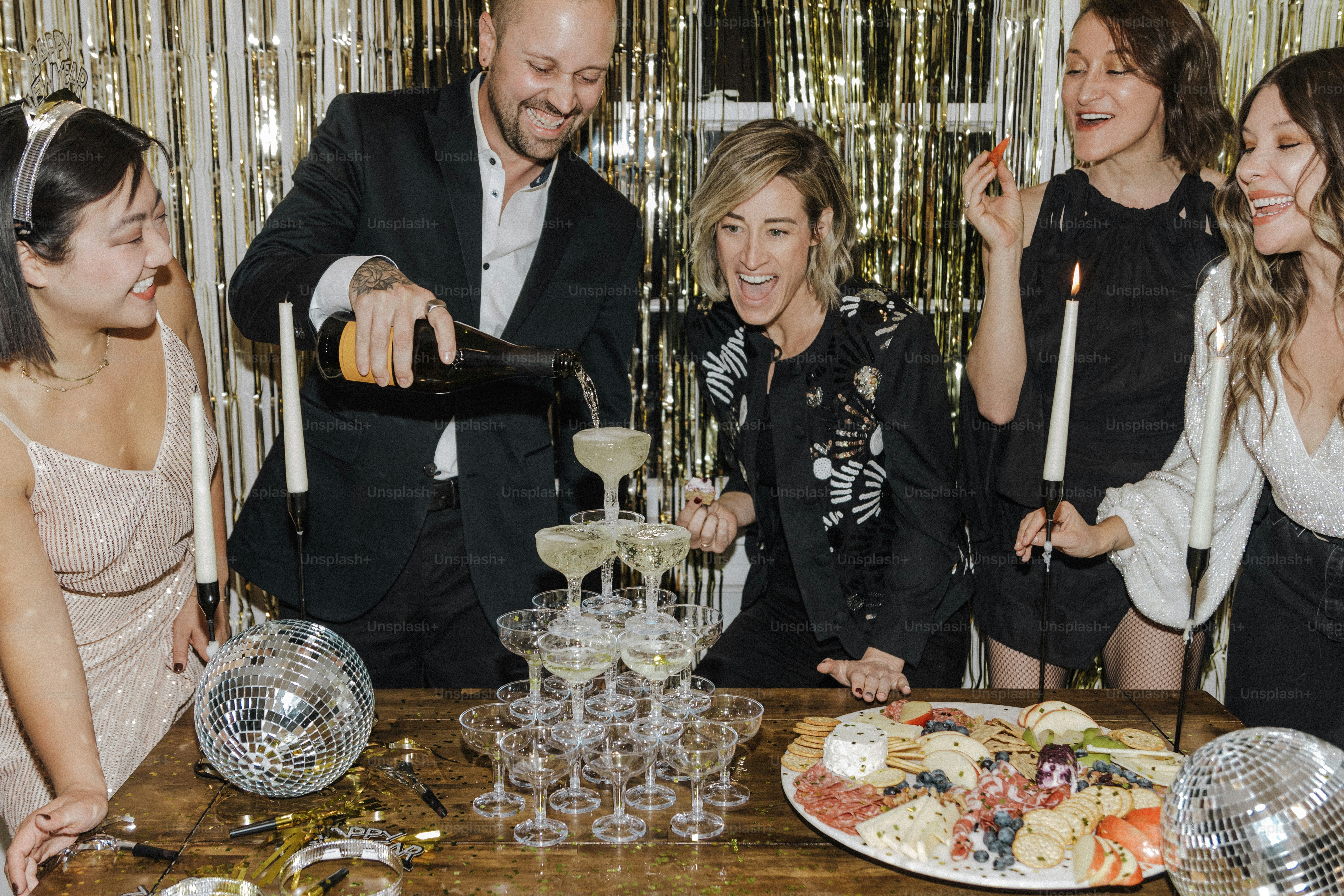 A group of people standing around a table photo – Nye Image on Unsplash