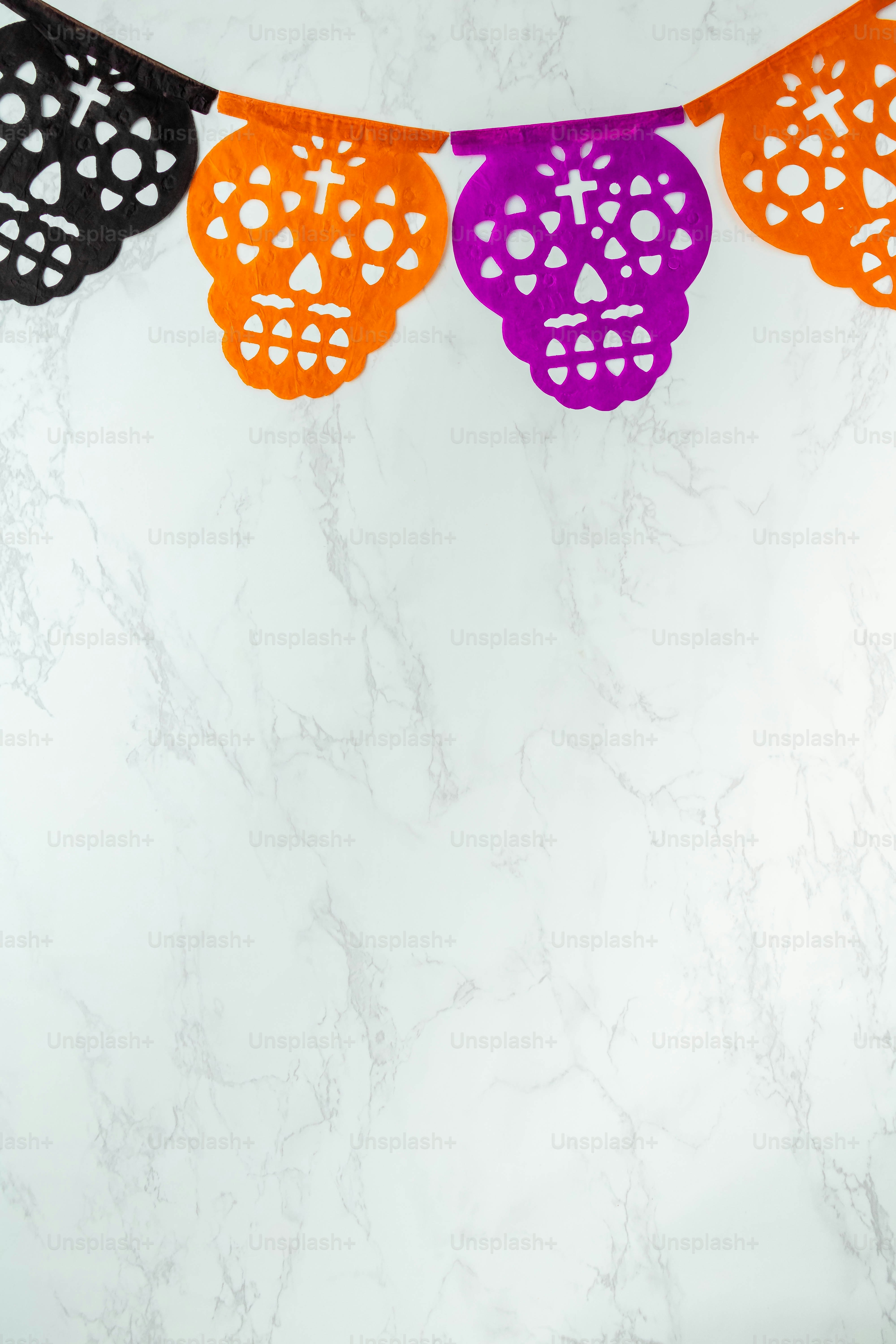 A colorful day of the dead banner on a marble wall photo – Calaveras ...