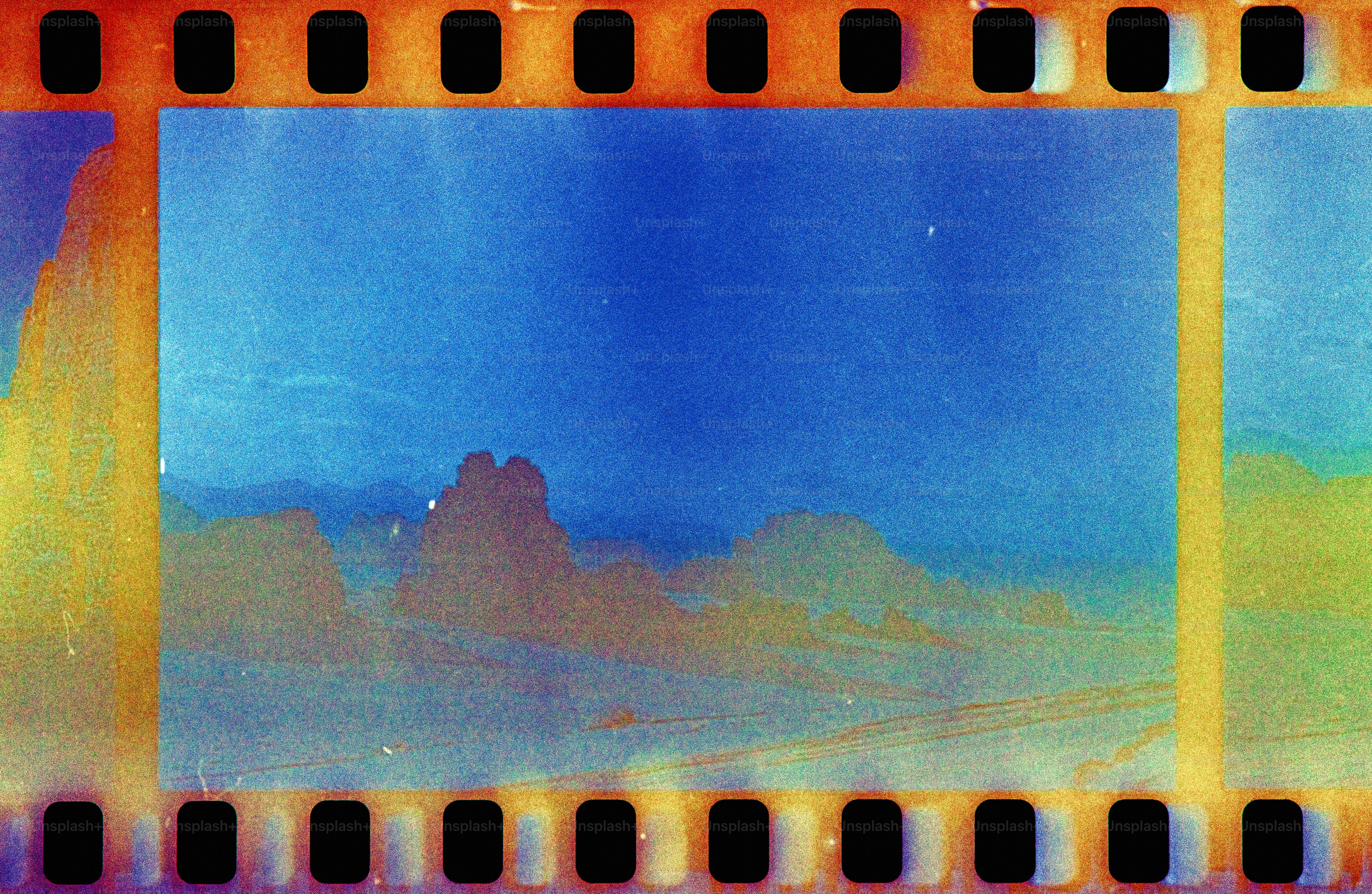 A film strip with a picture of mountains in the background photo ...