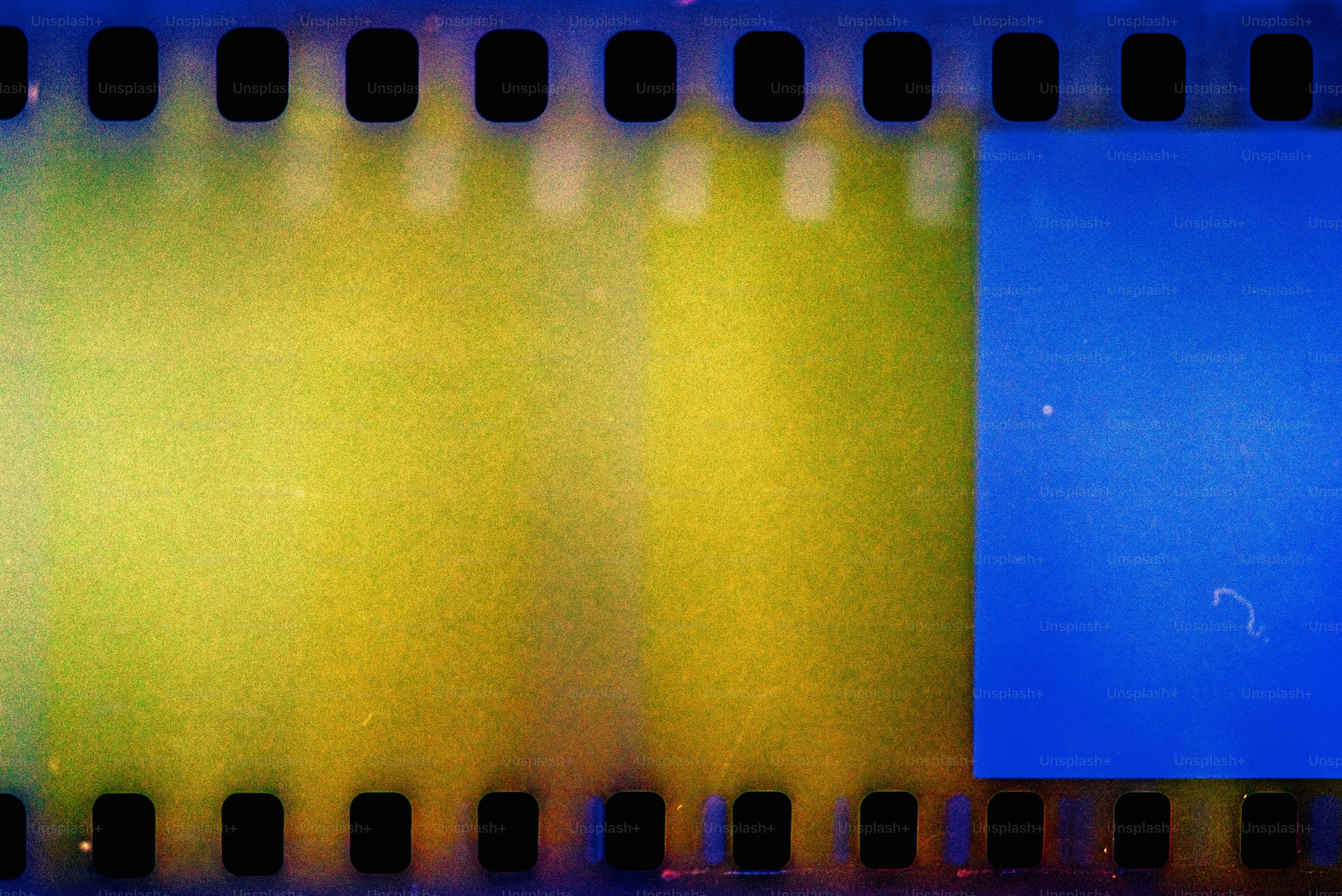 A close up of a film strip with blue and yellow squares photo – Color ...