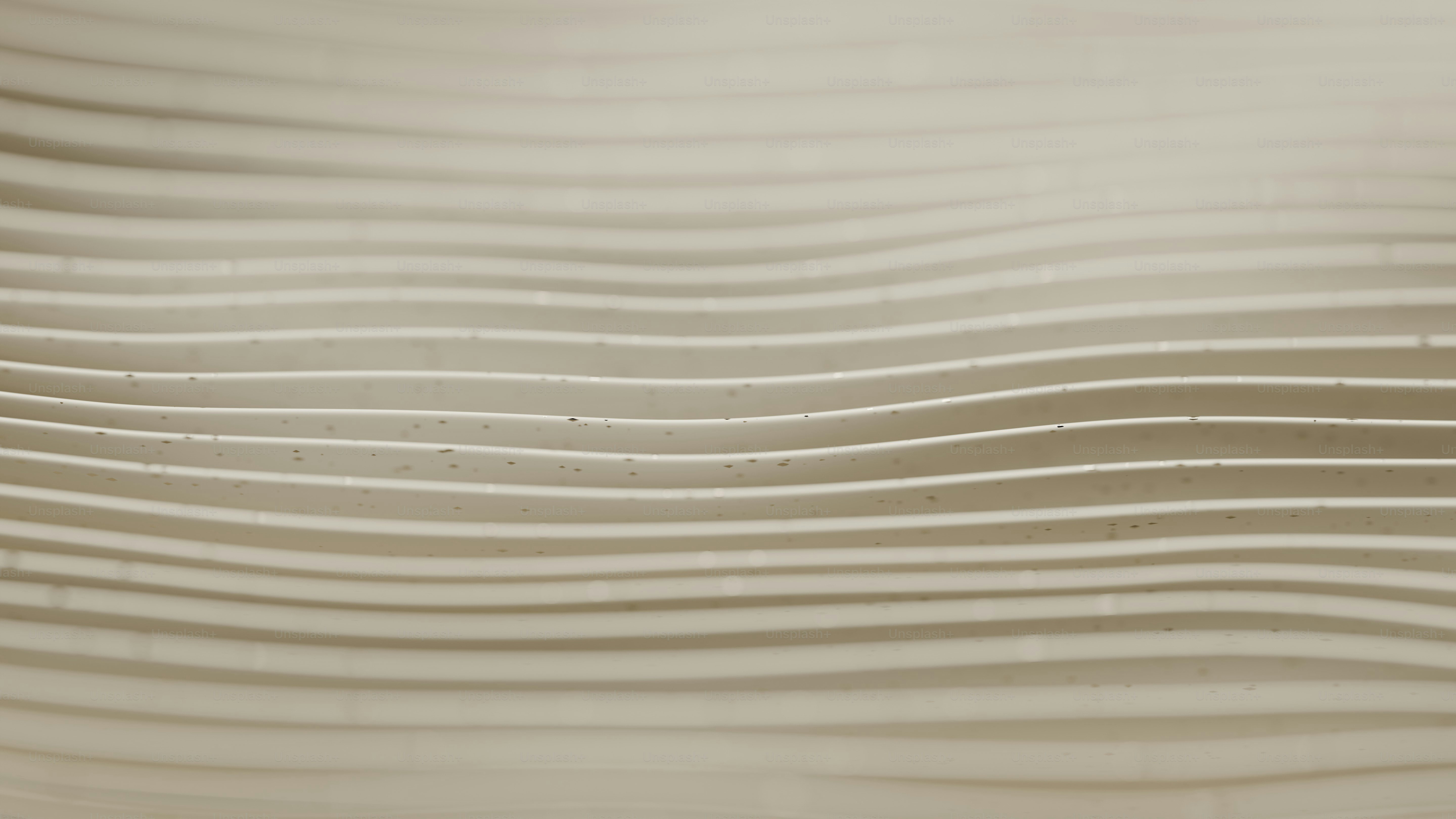 A close up of a wavy pattern on a wall photo – Wallpaper Image on Unsplash