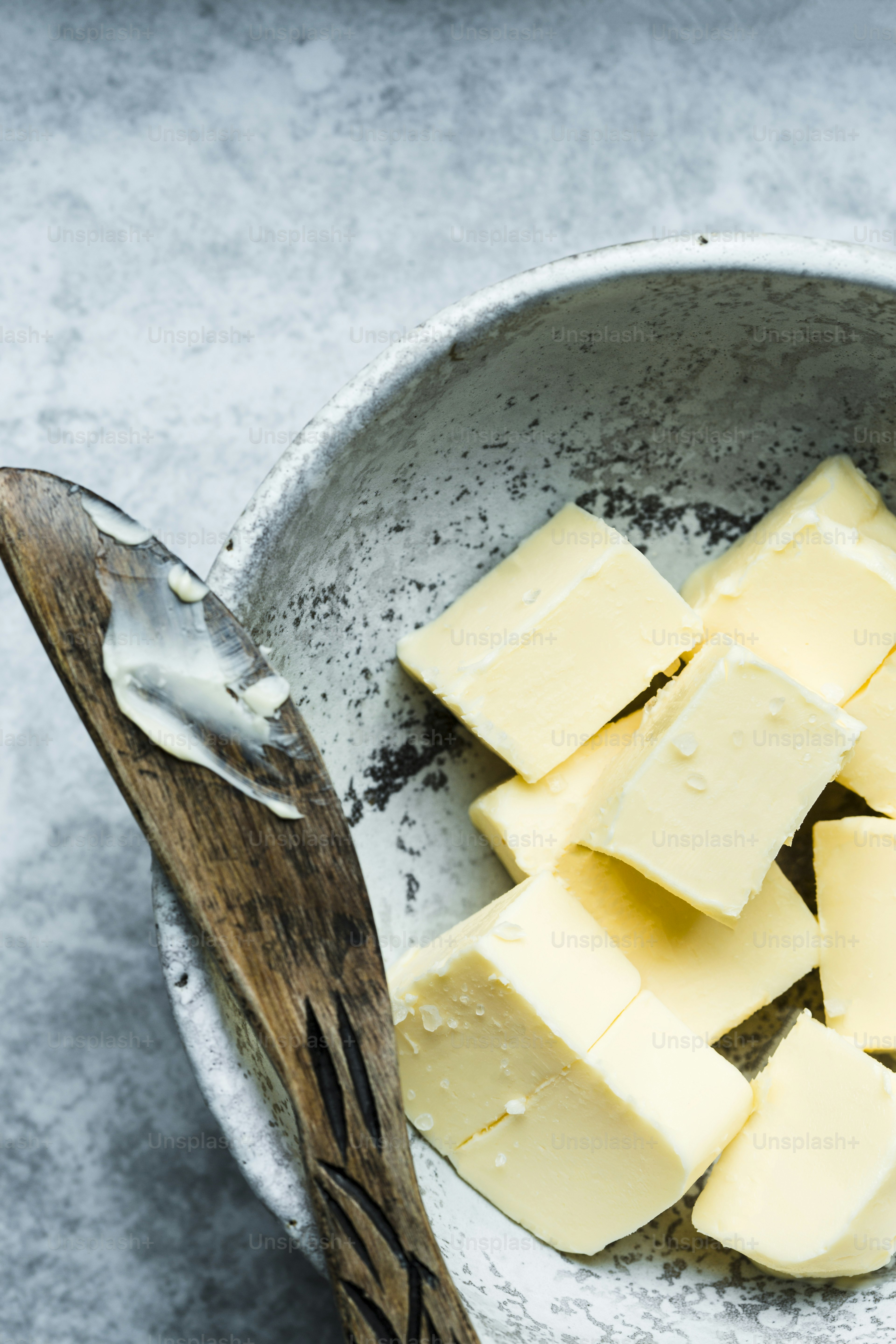 A bowl of butter and a wooden spoon photo – Butter Image on Unsplash