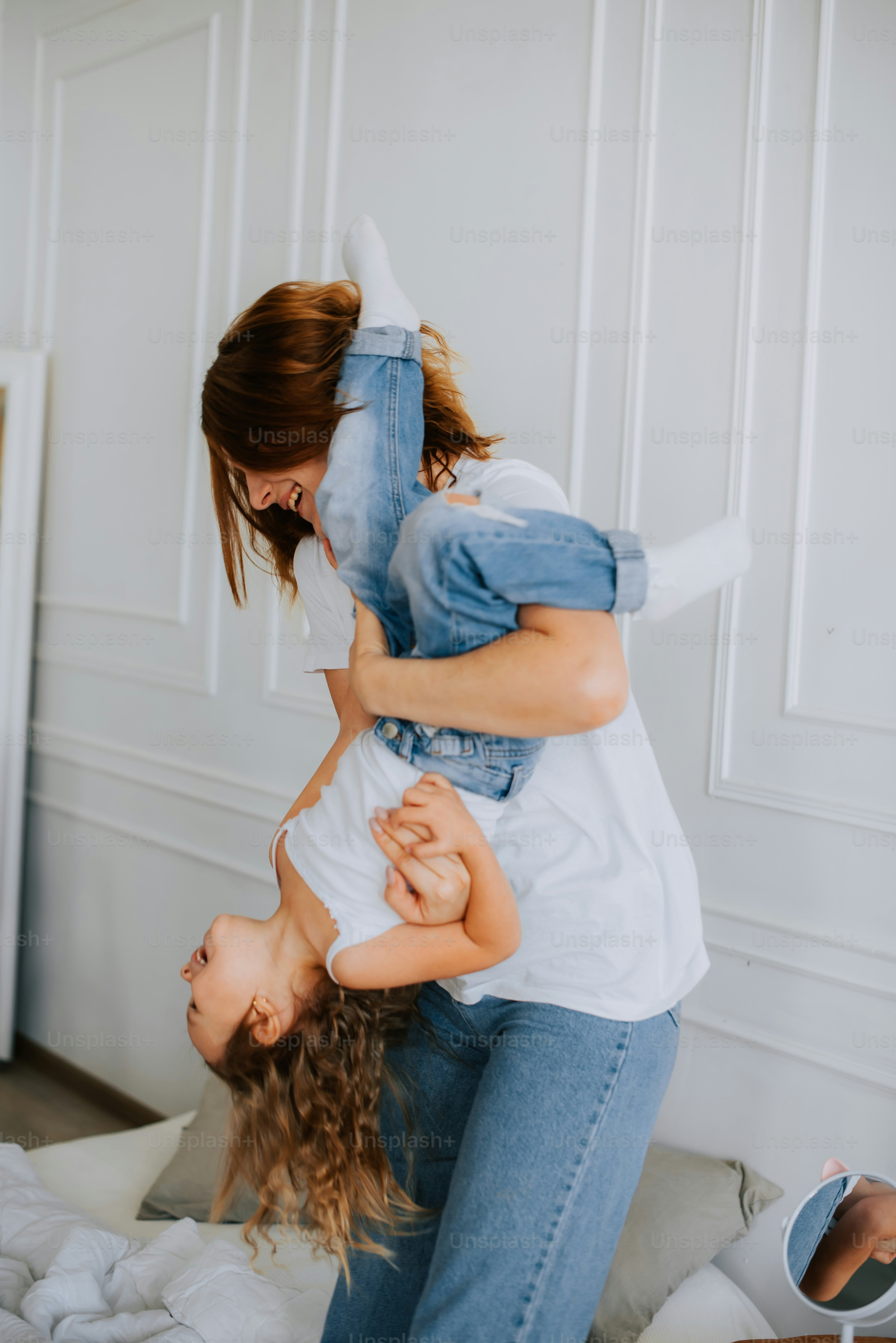 A woman holding a little girl on her back photo – Parenting Image on ...