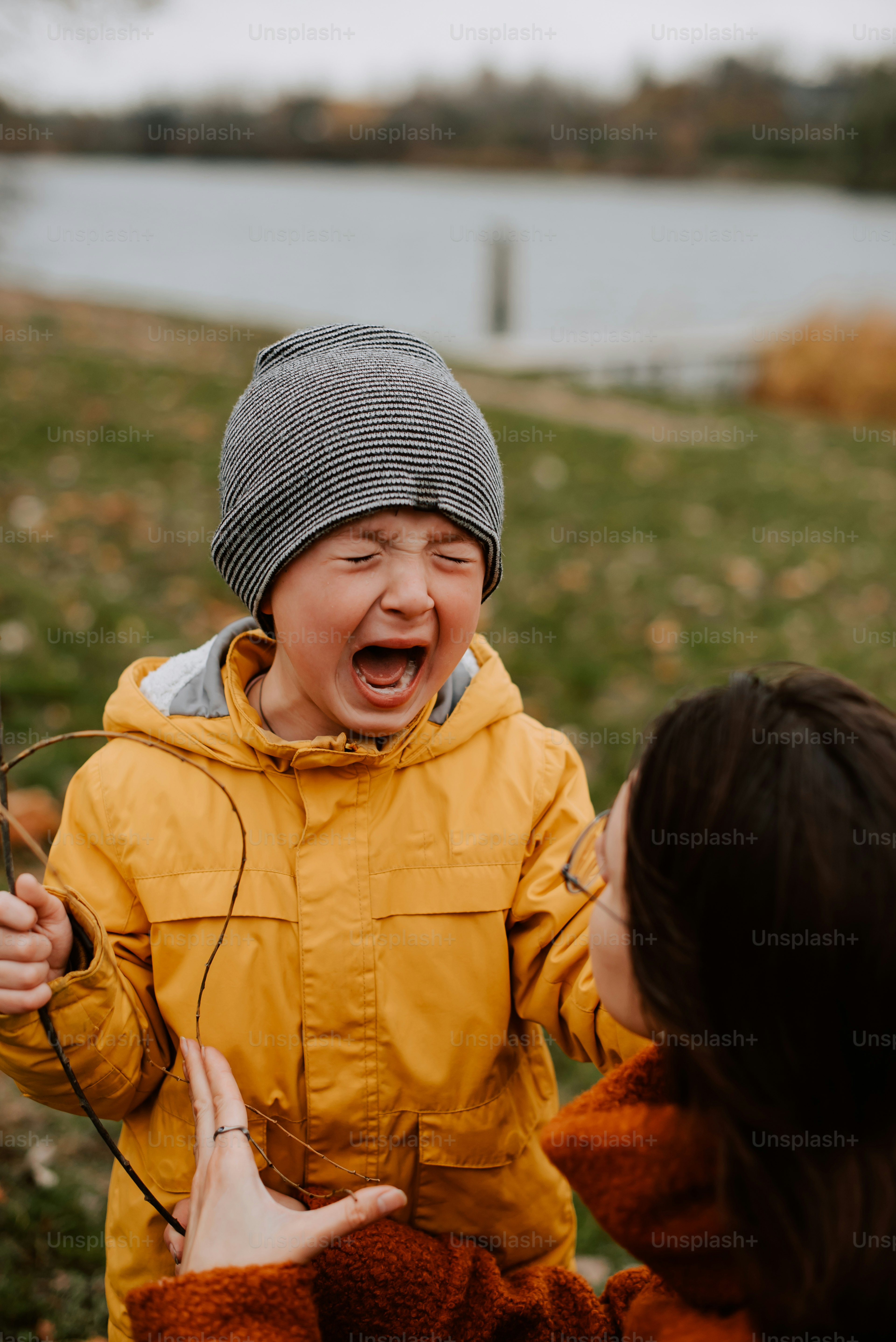 A woman holding a child with a surprised look on their face photo ...
