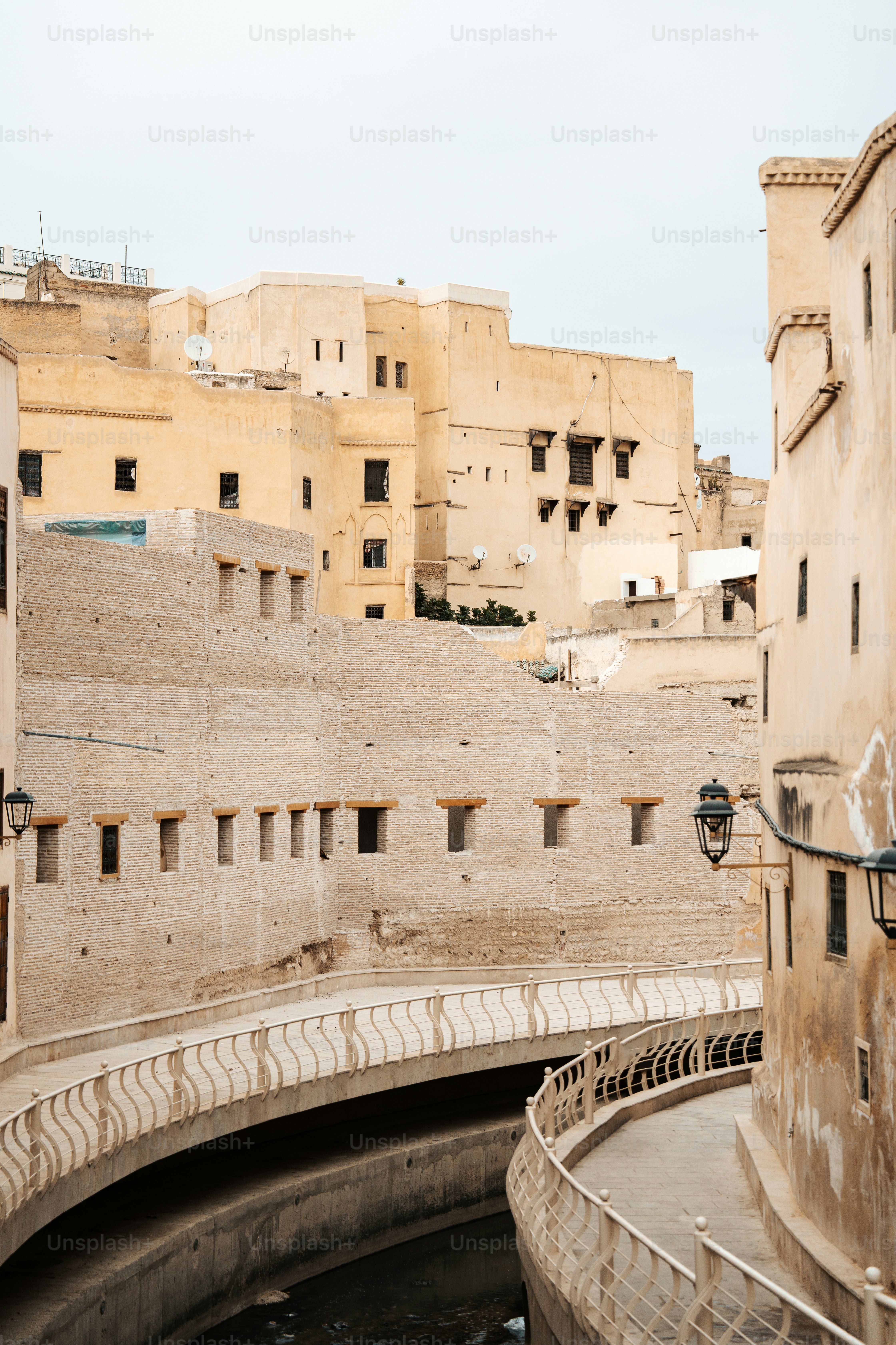 A building with a bridge going through it photo – Fortress Image on ...
