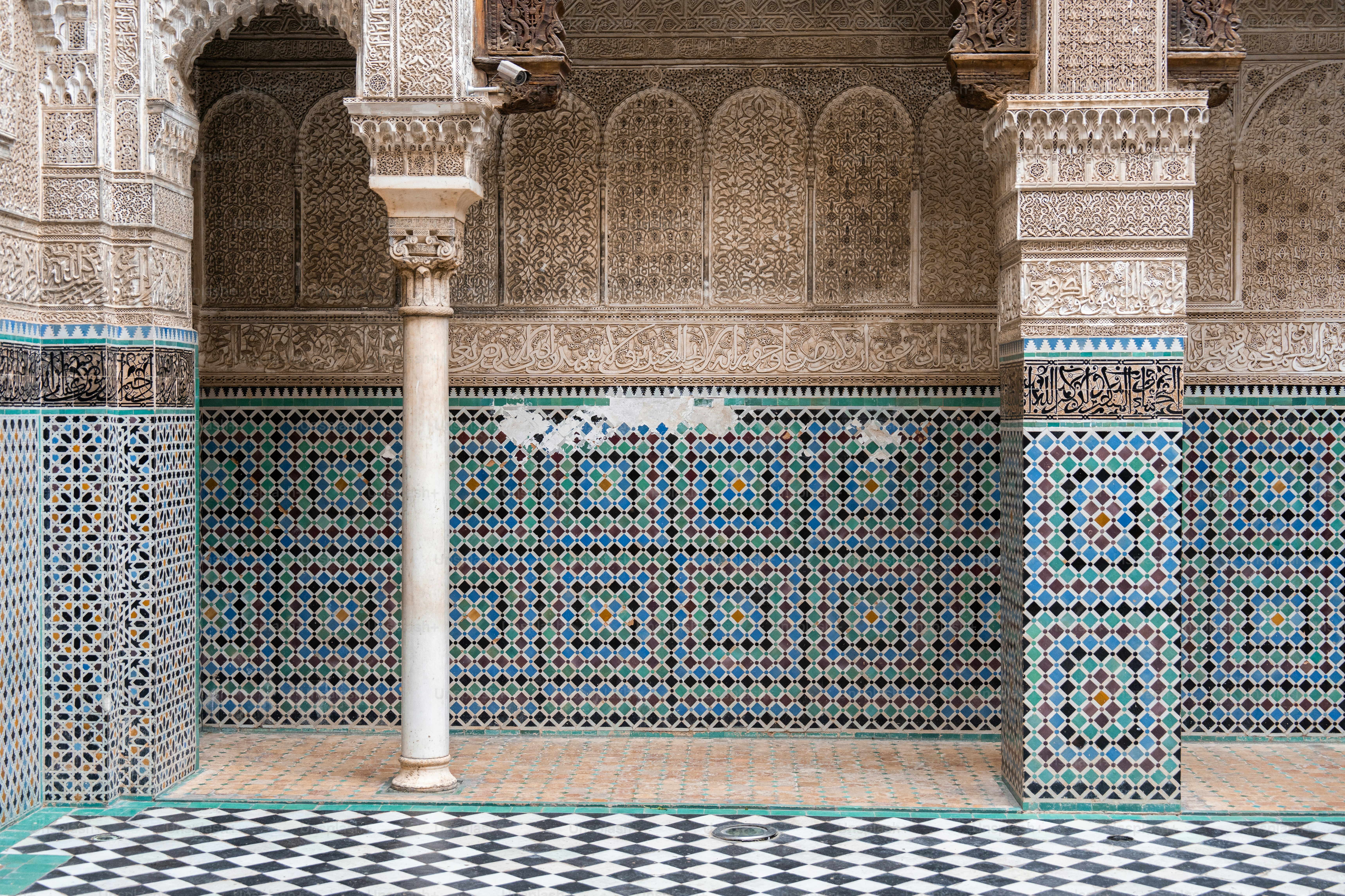 A tiled room with columns and a tiled floor photo – Building Image on ...