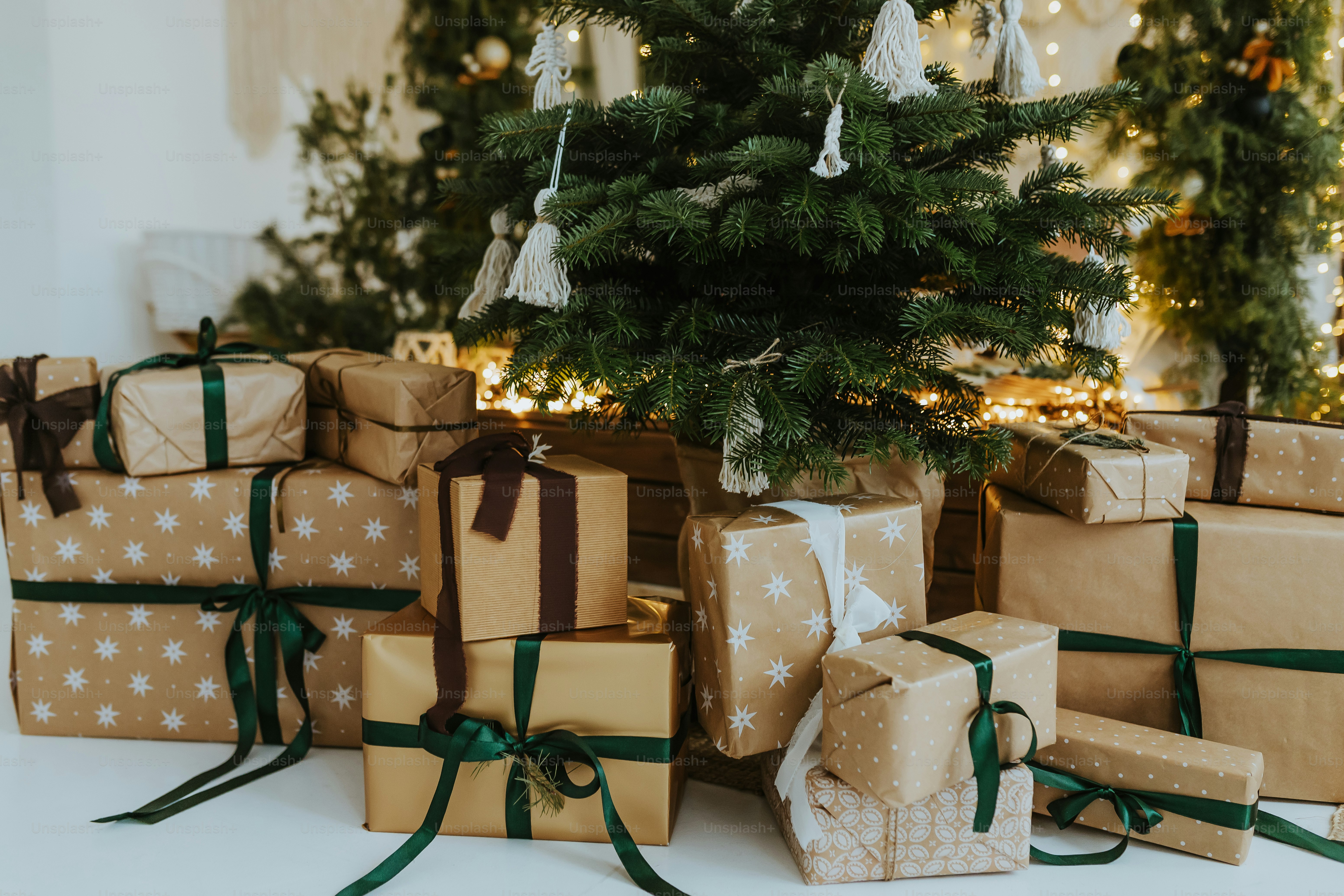 A group of wrapped presents under a christmas tree photo – Christmas ...