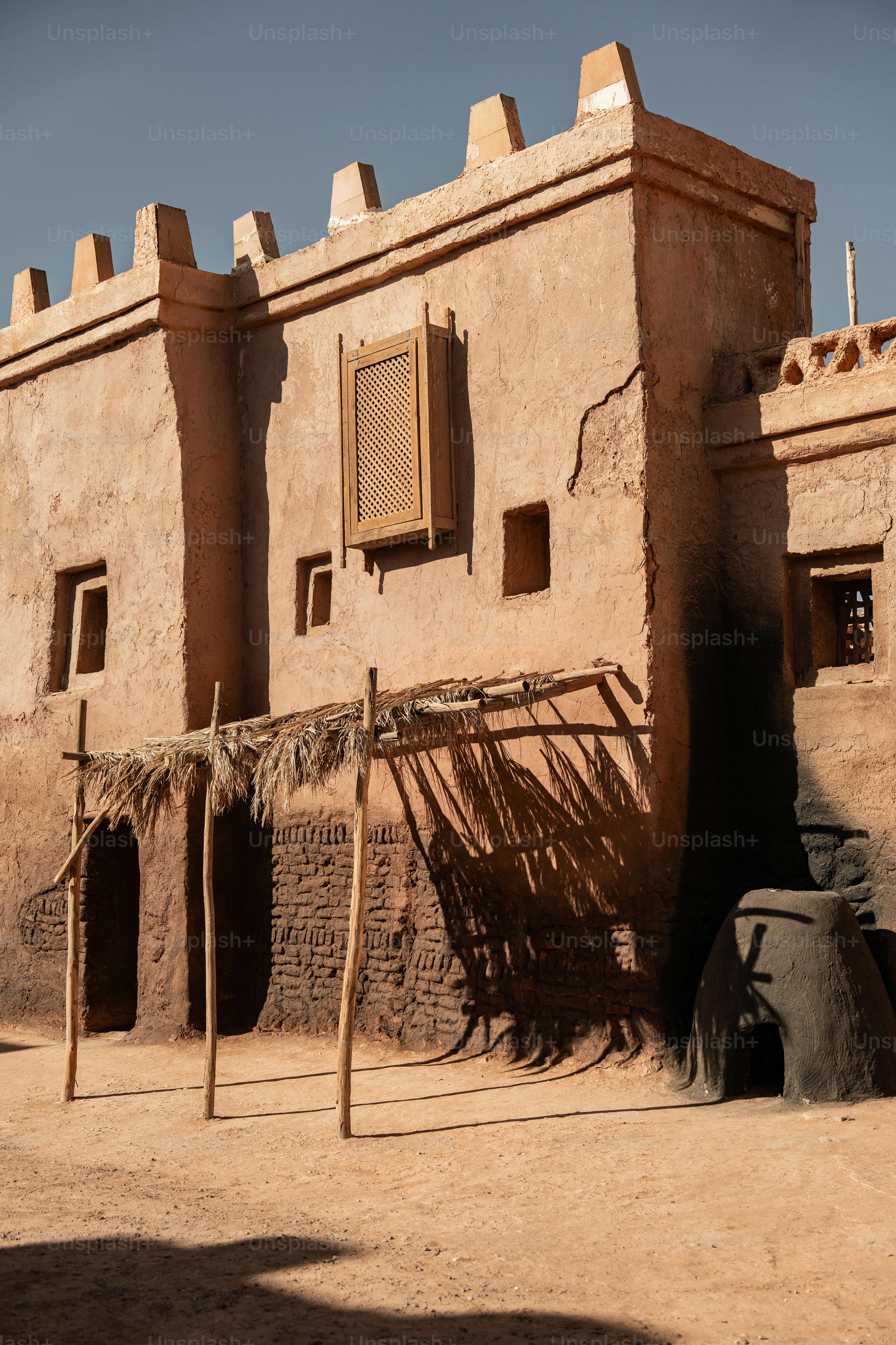 An adobe building with a window and a door photo – Building Image on ...