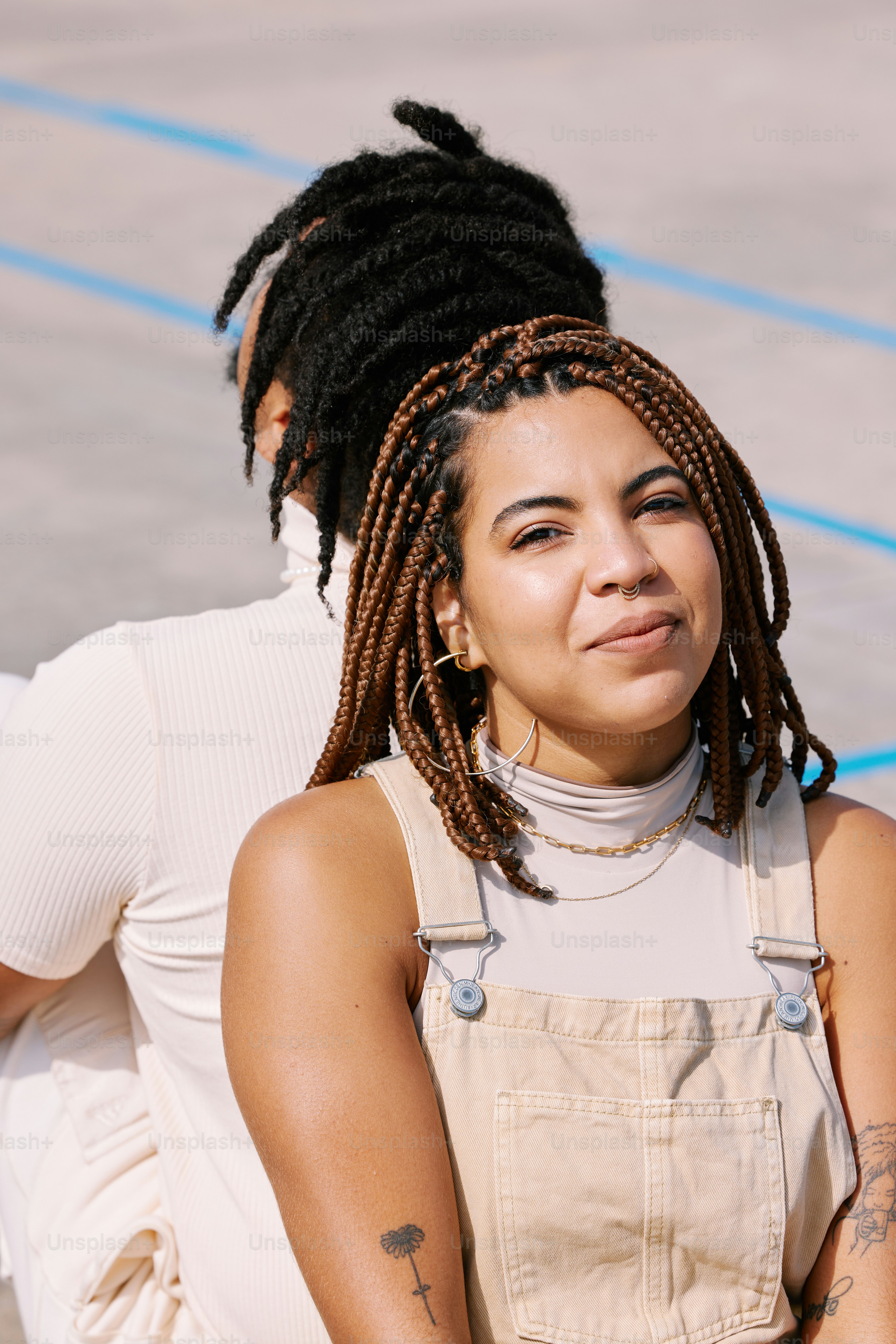 A woman with dreadlocks sitting on the ground photo – Fashion Image on ...