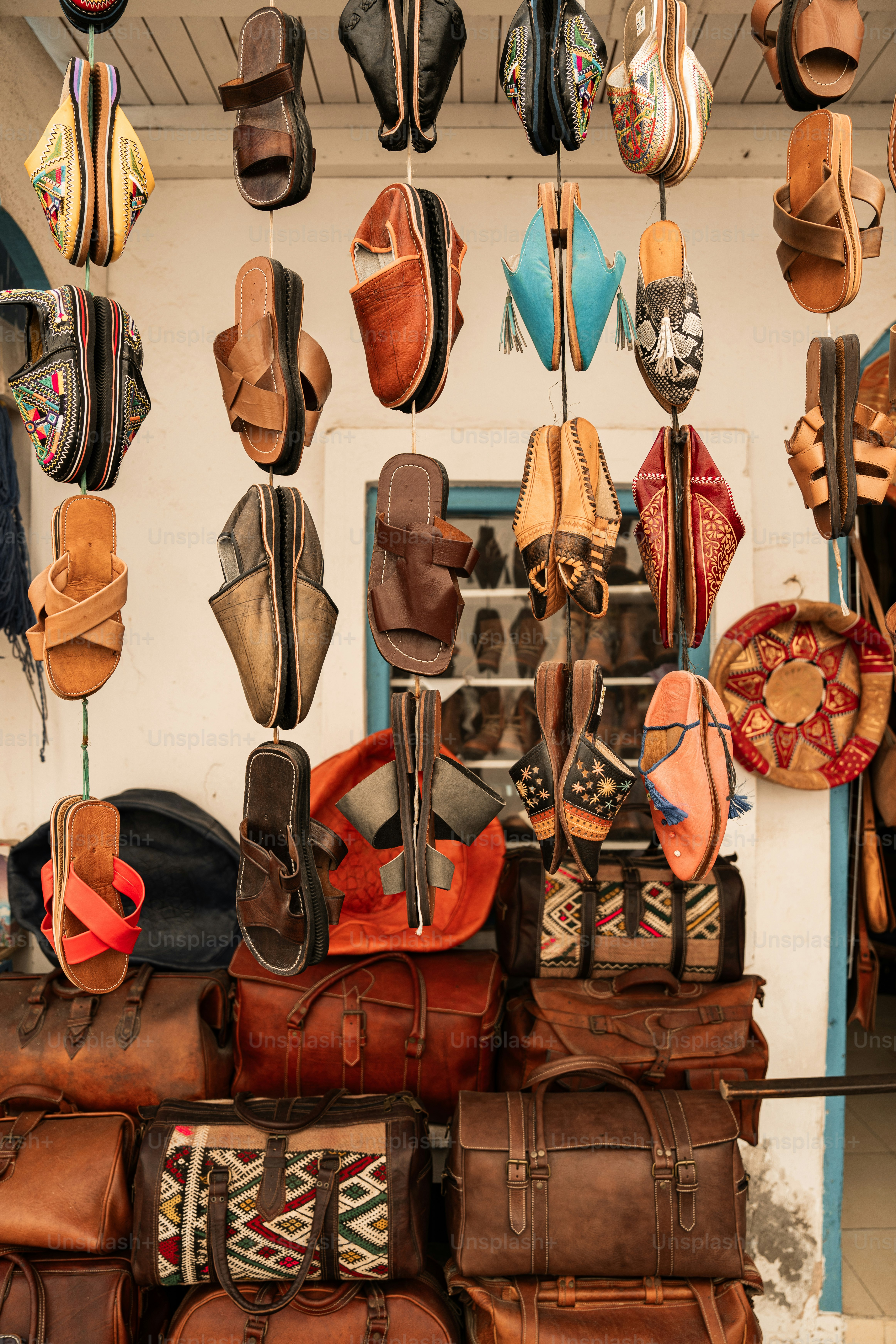 A bunch of shoes hanging up on a wall photo – Accessories Image on Unsplash