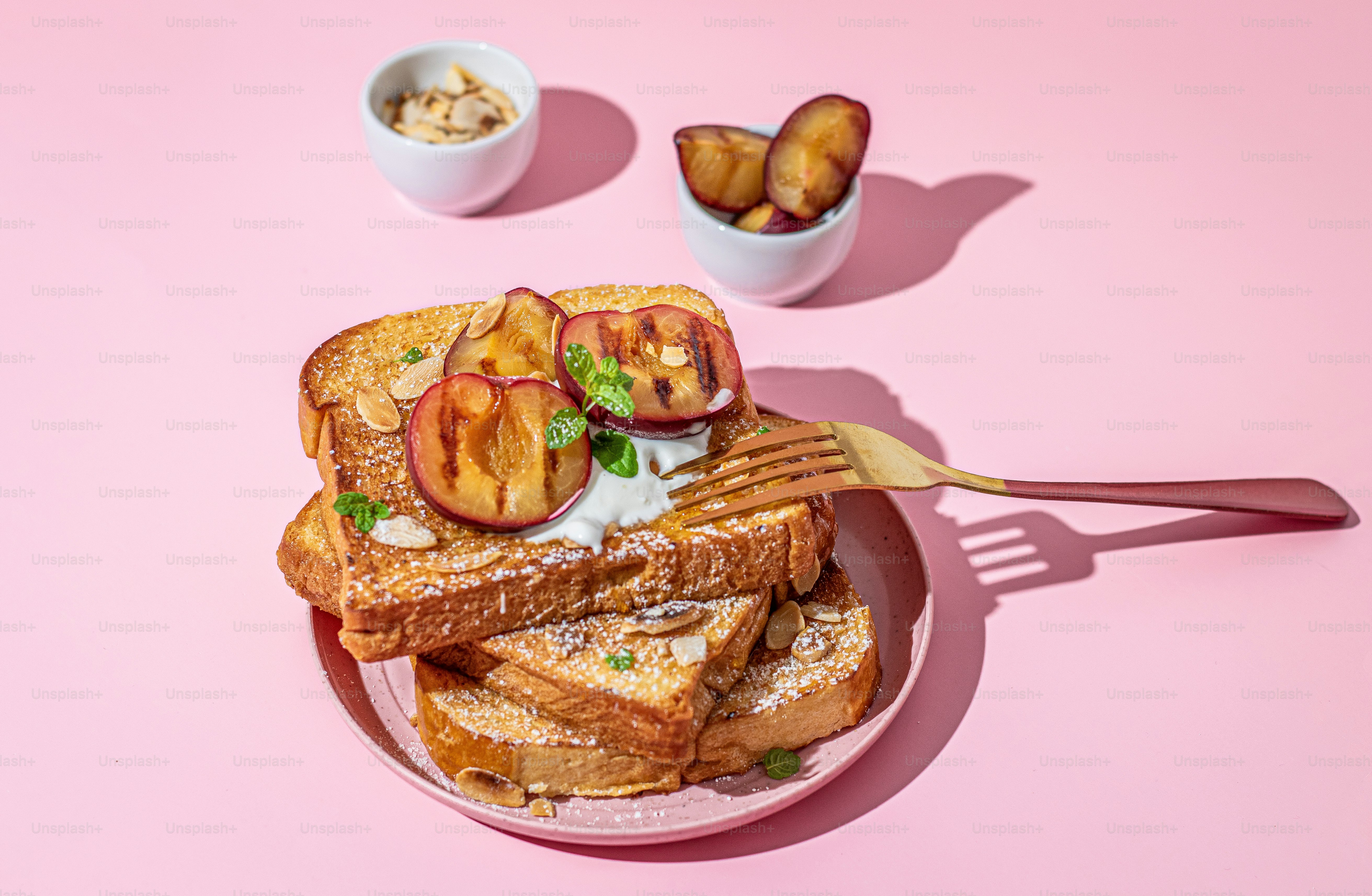 A pink table topped with a plate of french toast photo – Food Image on ...
