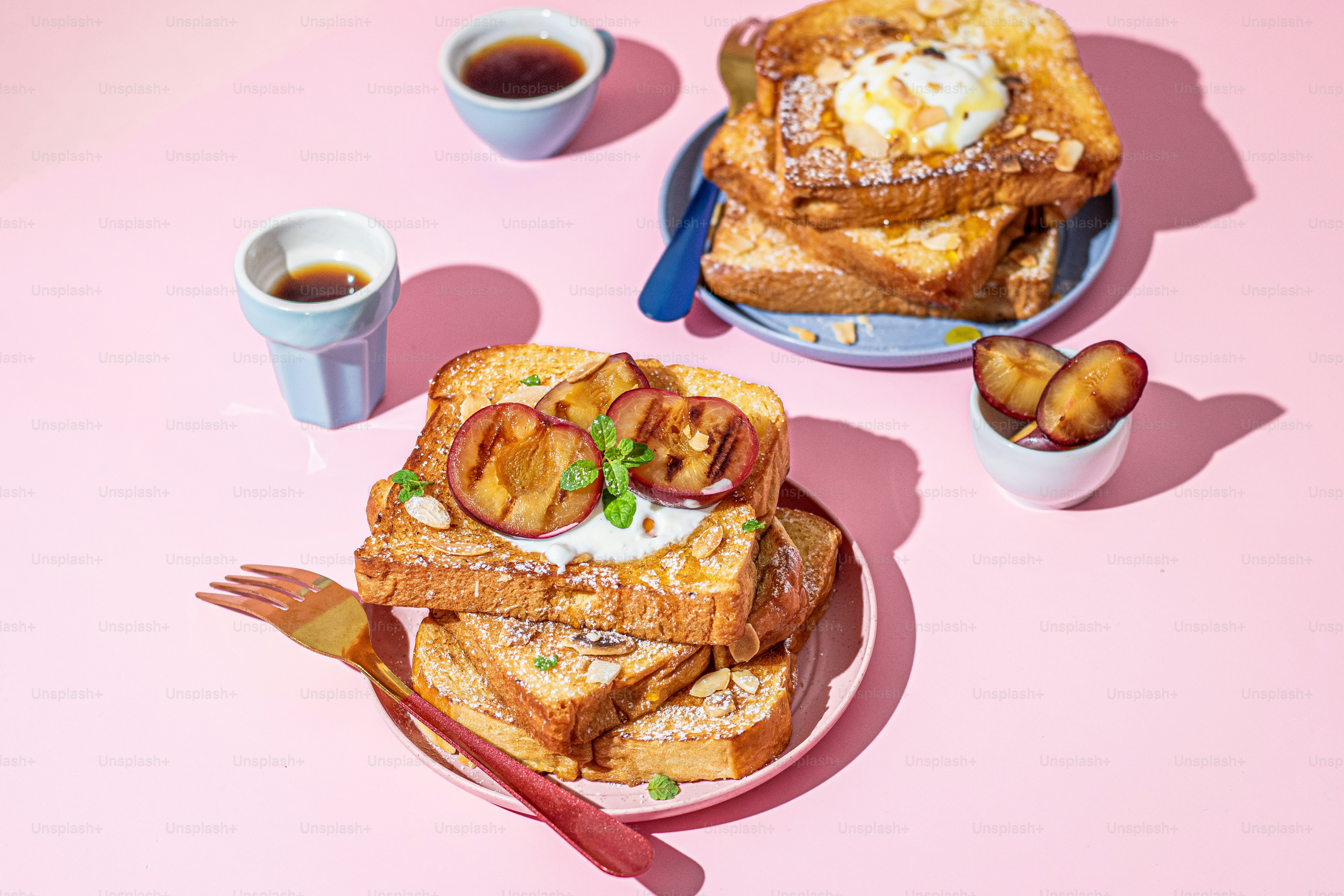 A pink table topped with a plate of french toast photo – Food Image on ...
