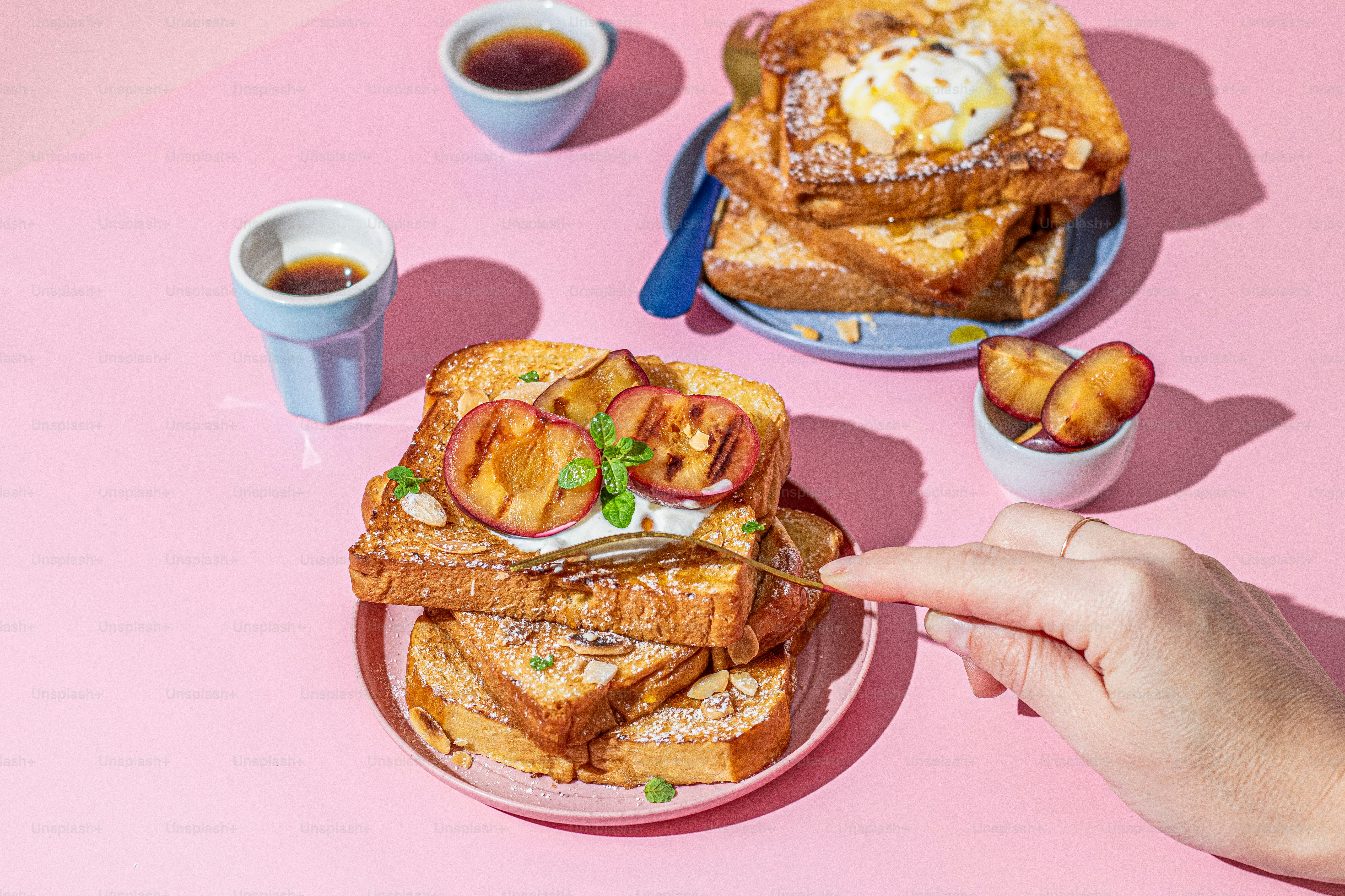 A pink table topped with a plate of french toast photo – Toast Image on ...