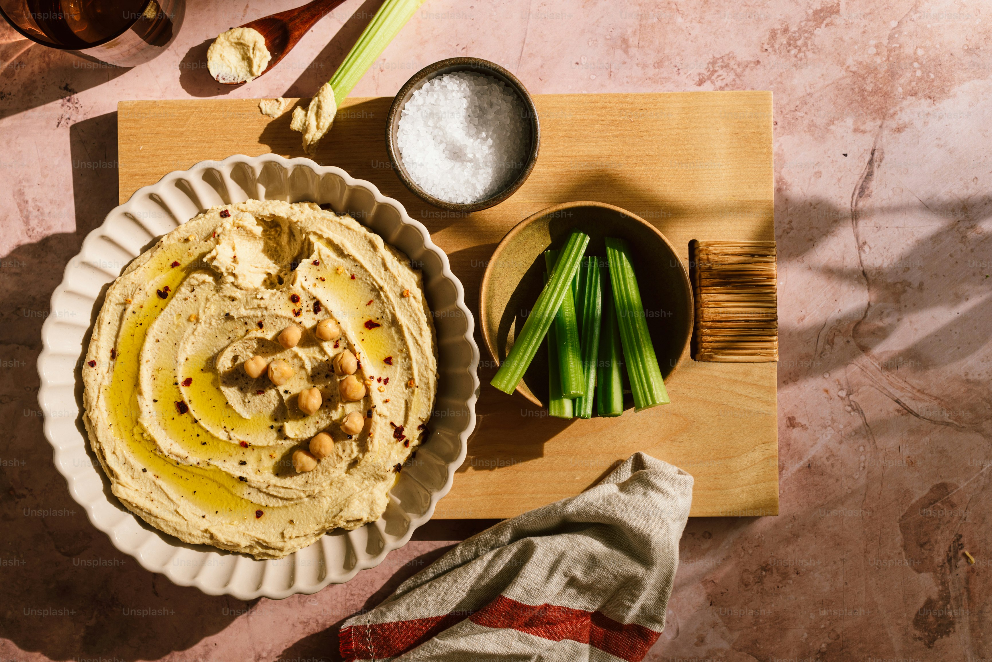 A bowl of hummus next to a bowl of celery sticks photo – Celery Image ...