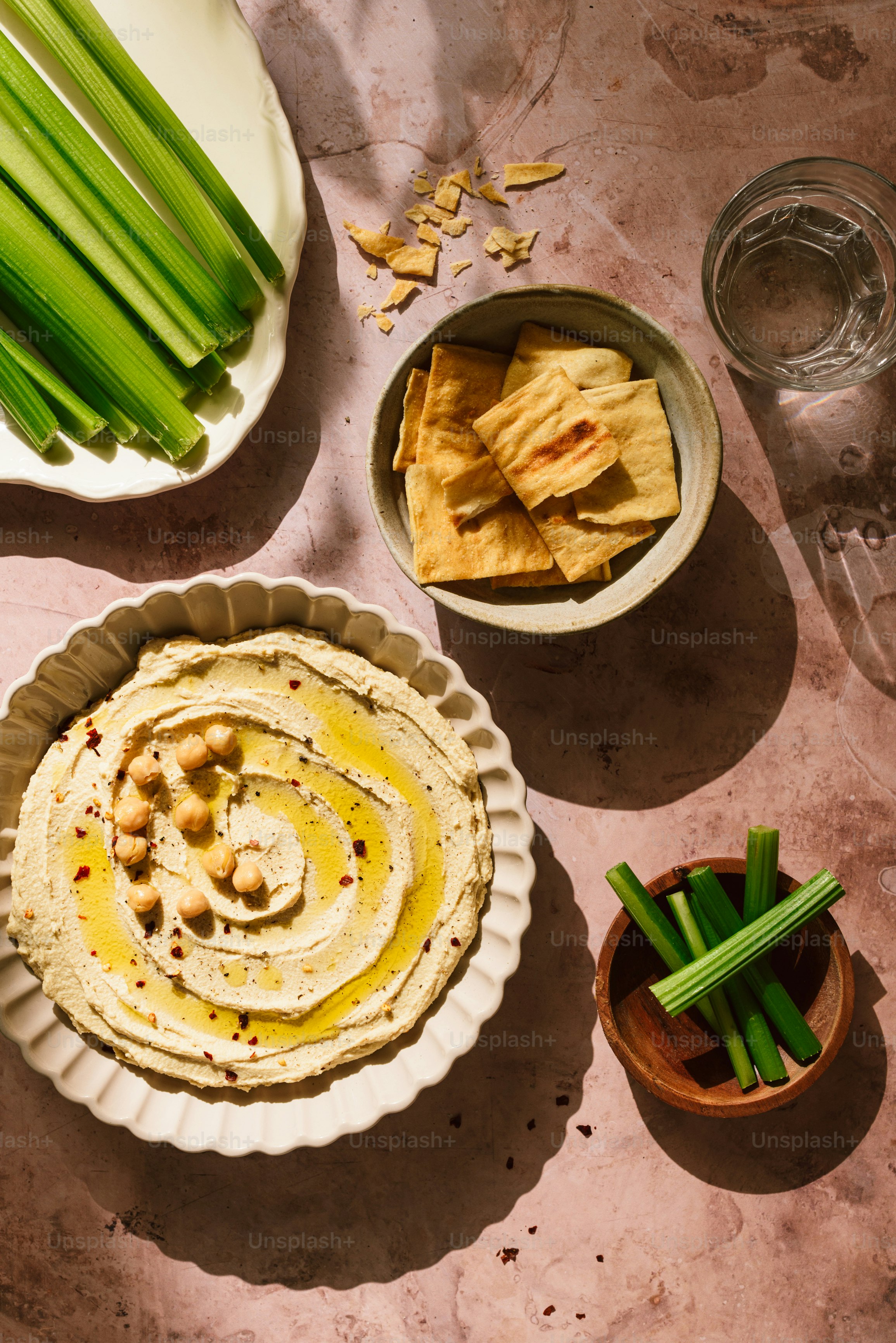 A bowl of hummus next to a bowl of celery sticks photo – Celery Image ...