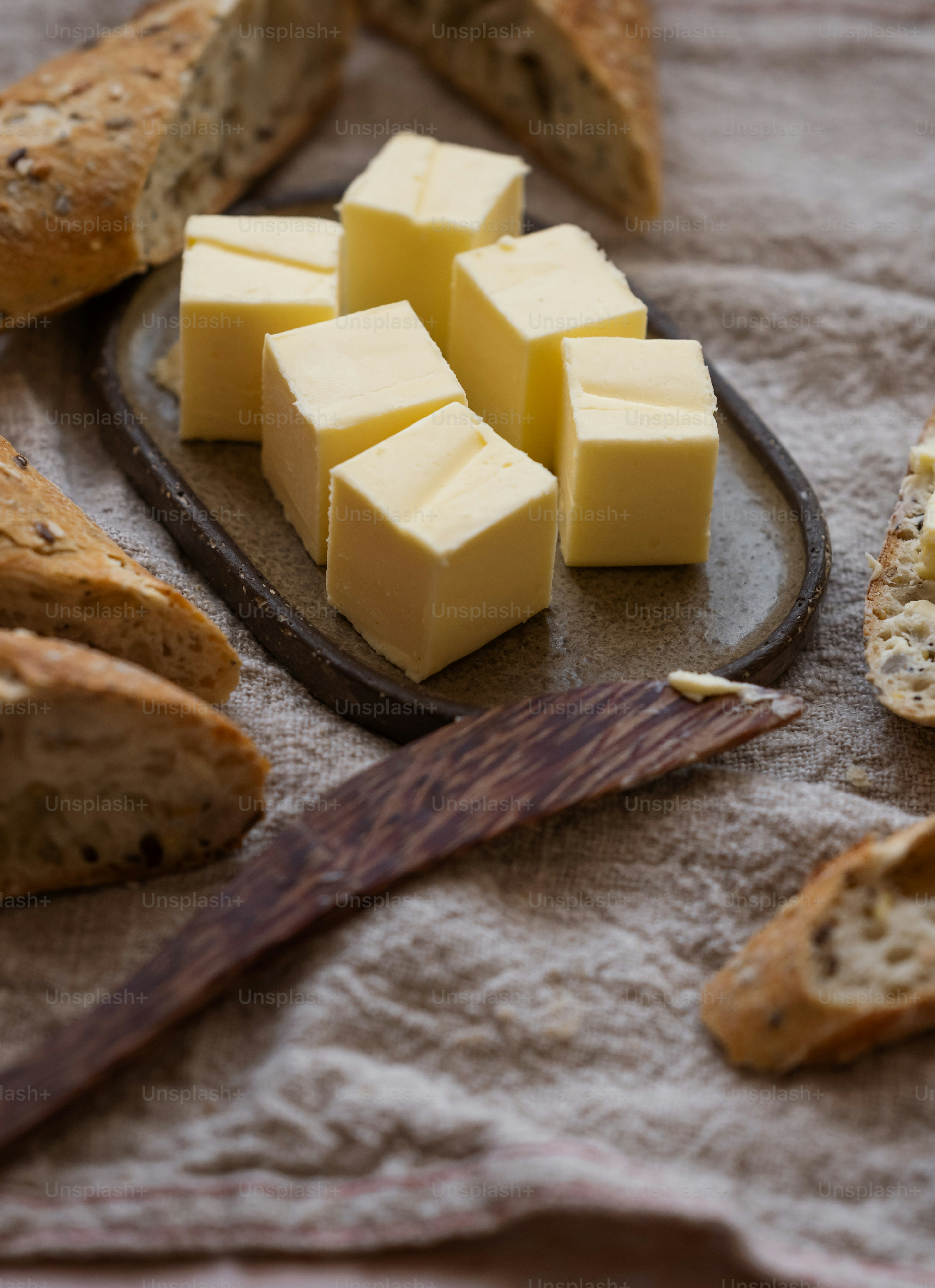 Bread, butter, and buttered cheese on a plate photo – Food Image on ...