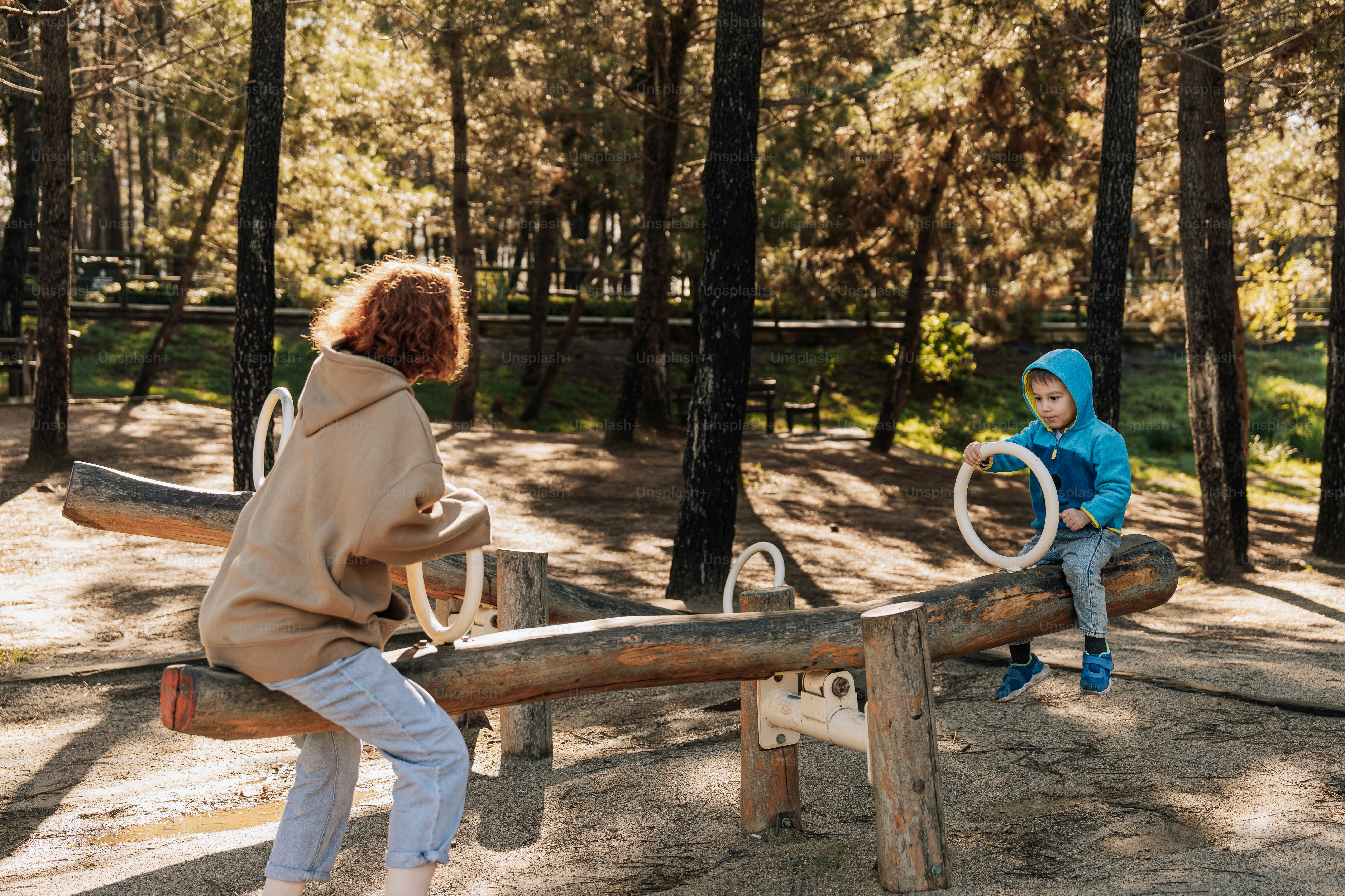 A little boy sitting on top of a wooden bench photo – Family Image on ...