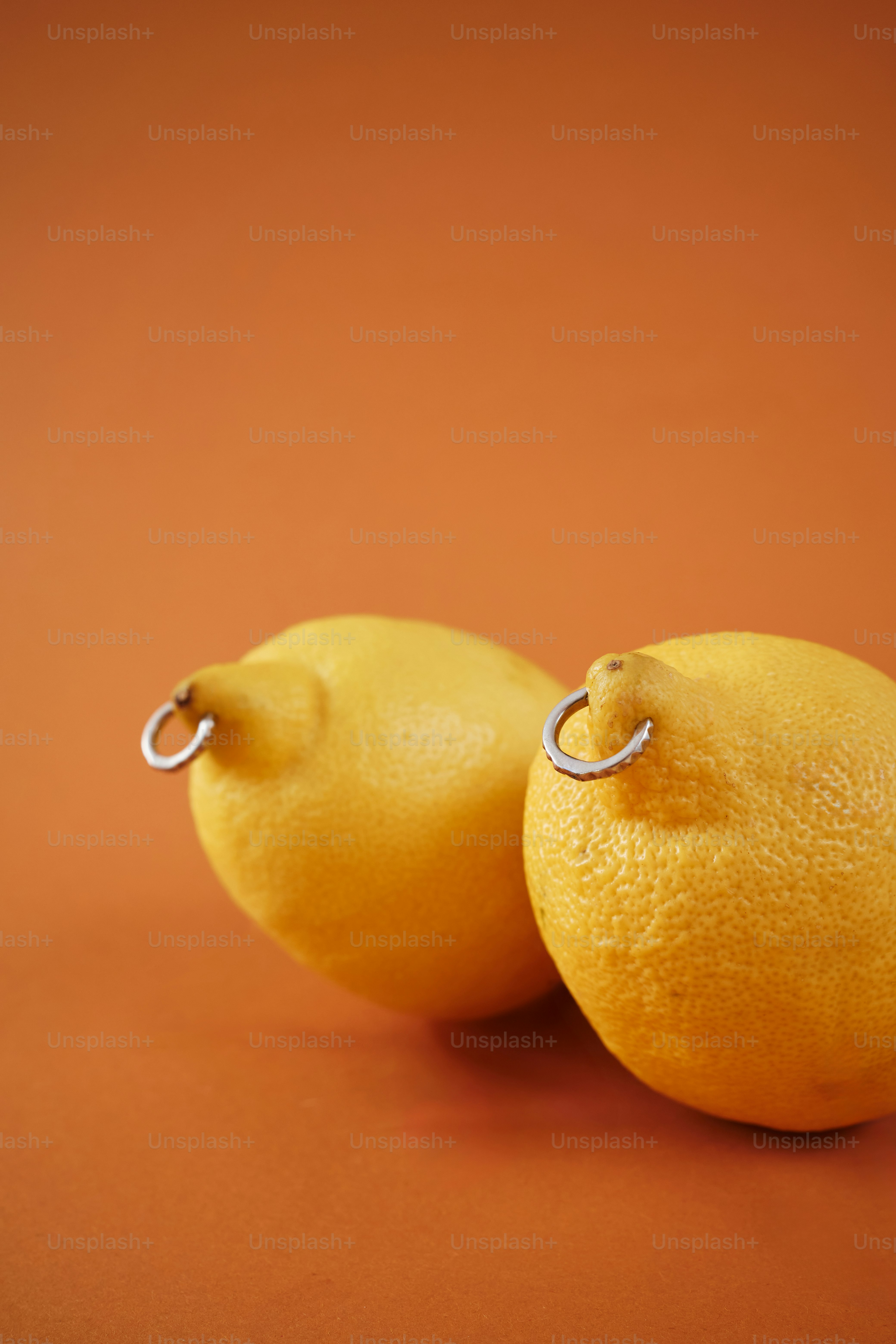 Two lemons sitting next to each other on a table photo – Sexual ...