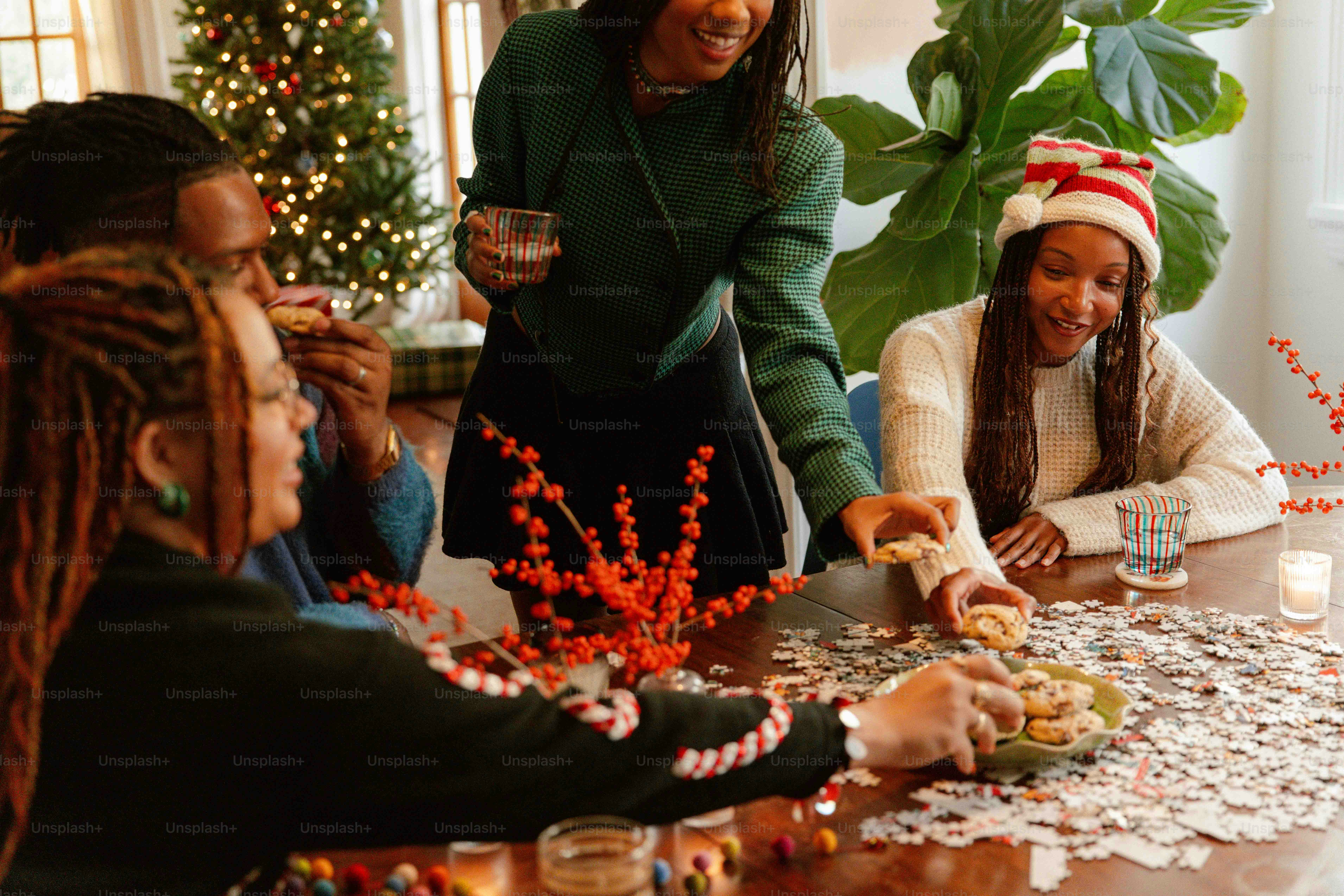 A group of people sitting around a living room photo – Celebrating ...