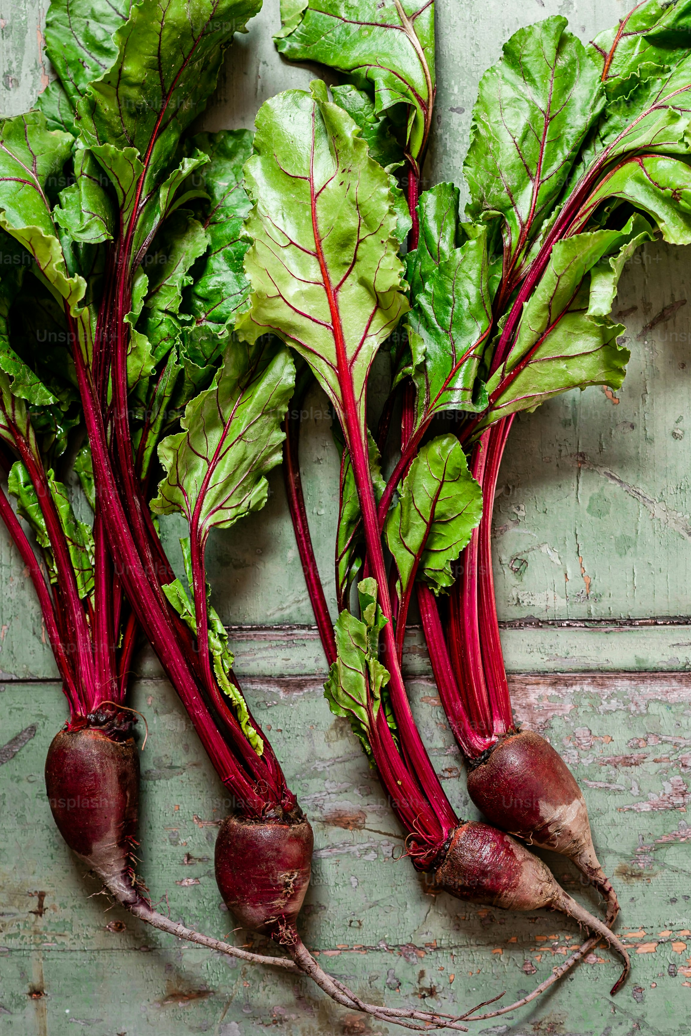 A group of radishes sitting on top of a wooden table photo – Fresh ...