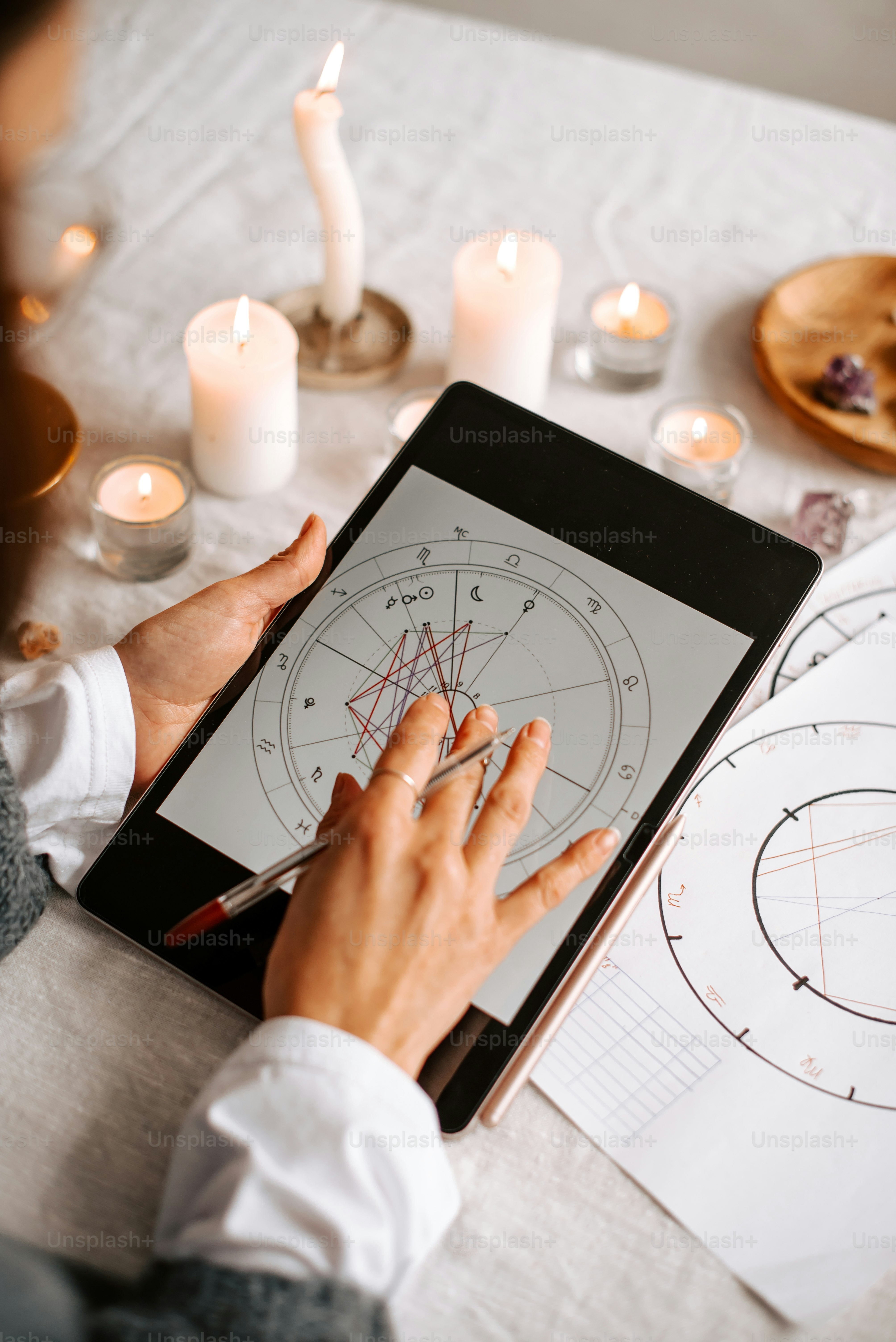 A person using a tablet on a table with candles photo – Cancer Image on ...