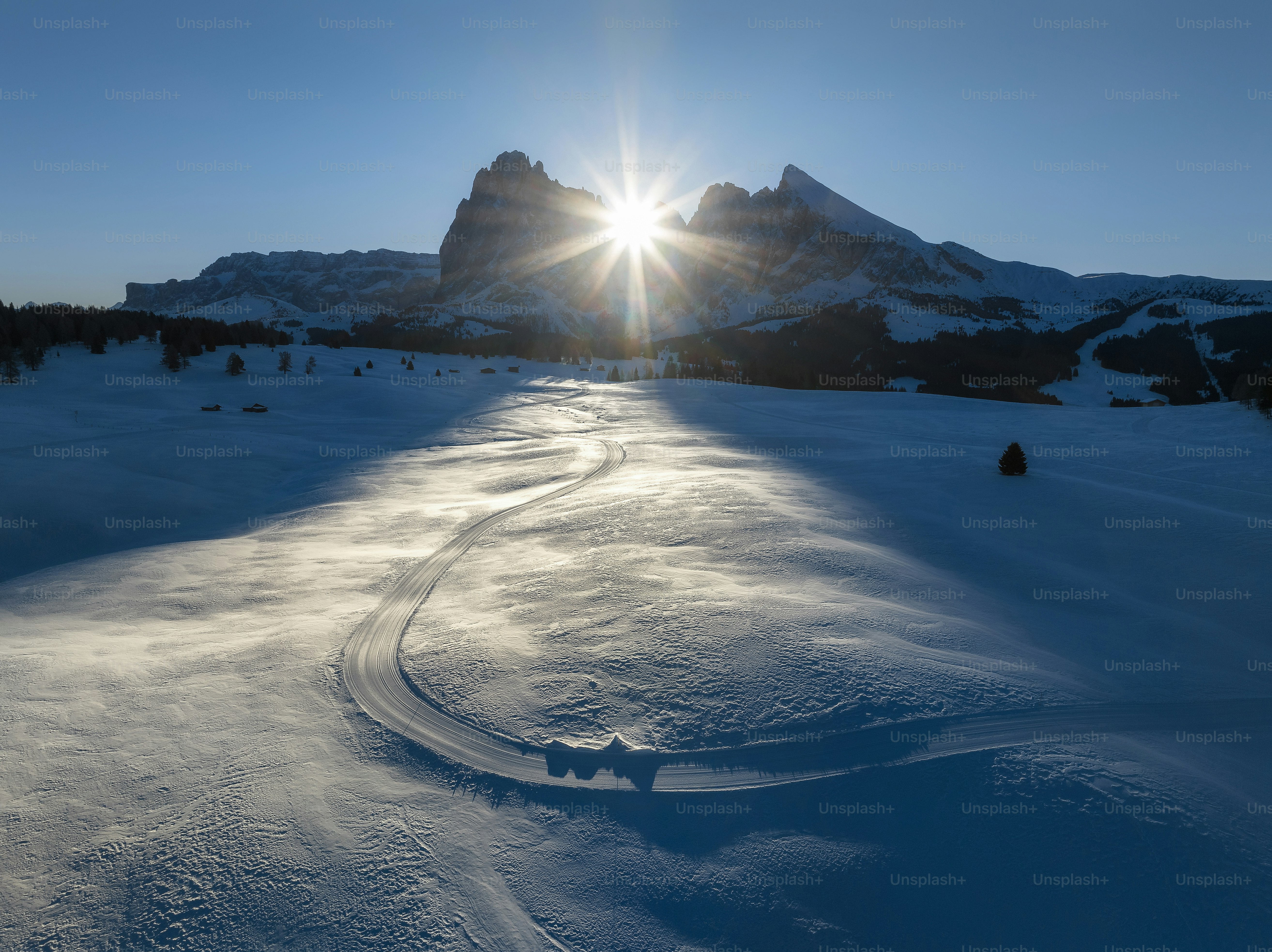 The sun shines brightly over a snowy landscape photo – Travel Image on ...