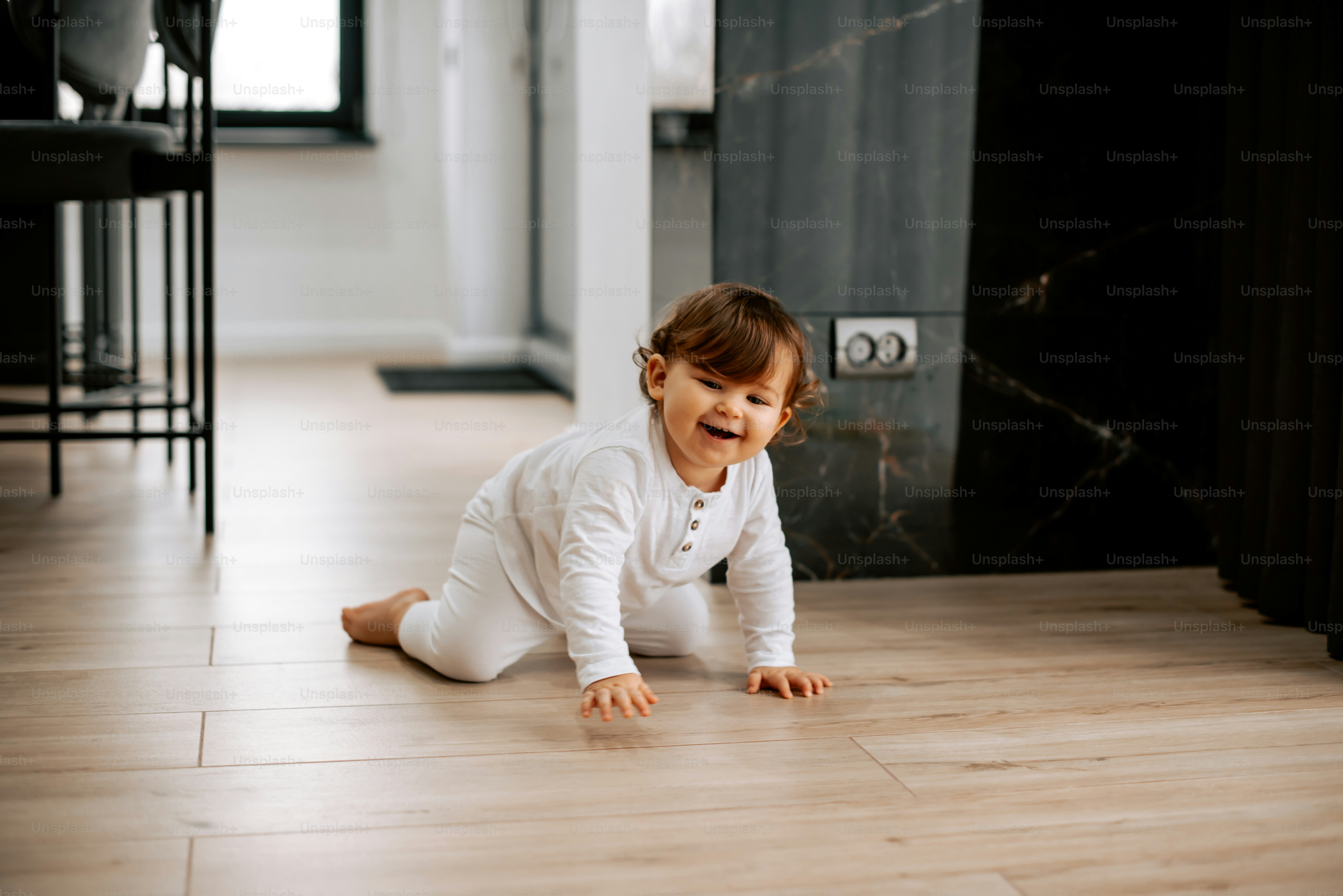 A baby crawling on the floor in a room photo – Family Image on Unsplash