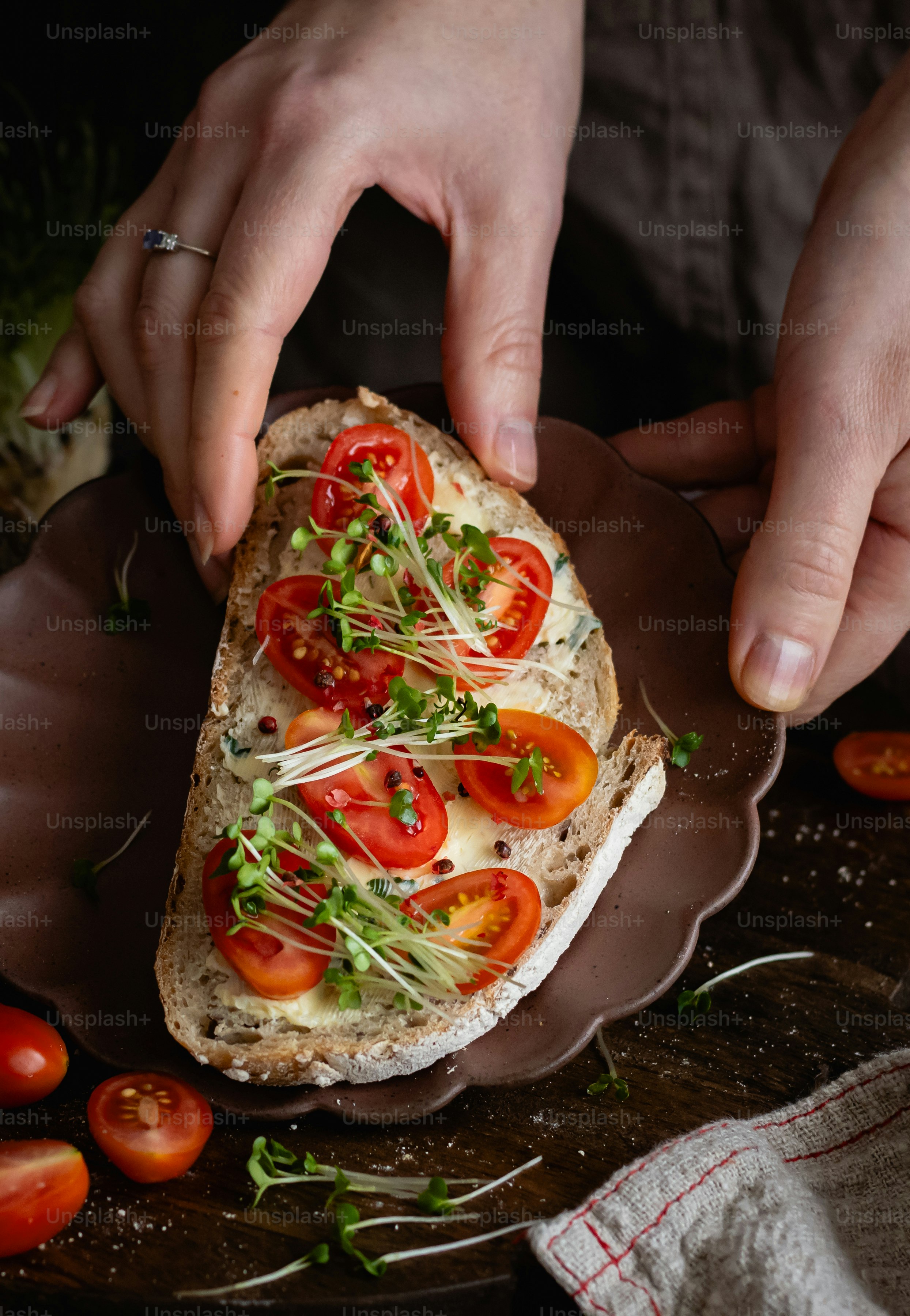 A person putting toppings on a piece of bread photo – Sourdough bread ...