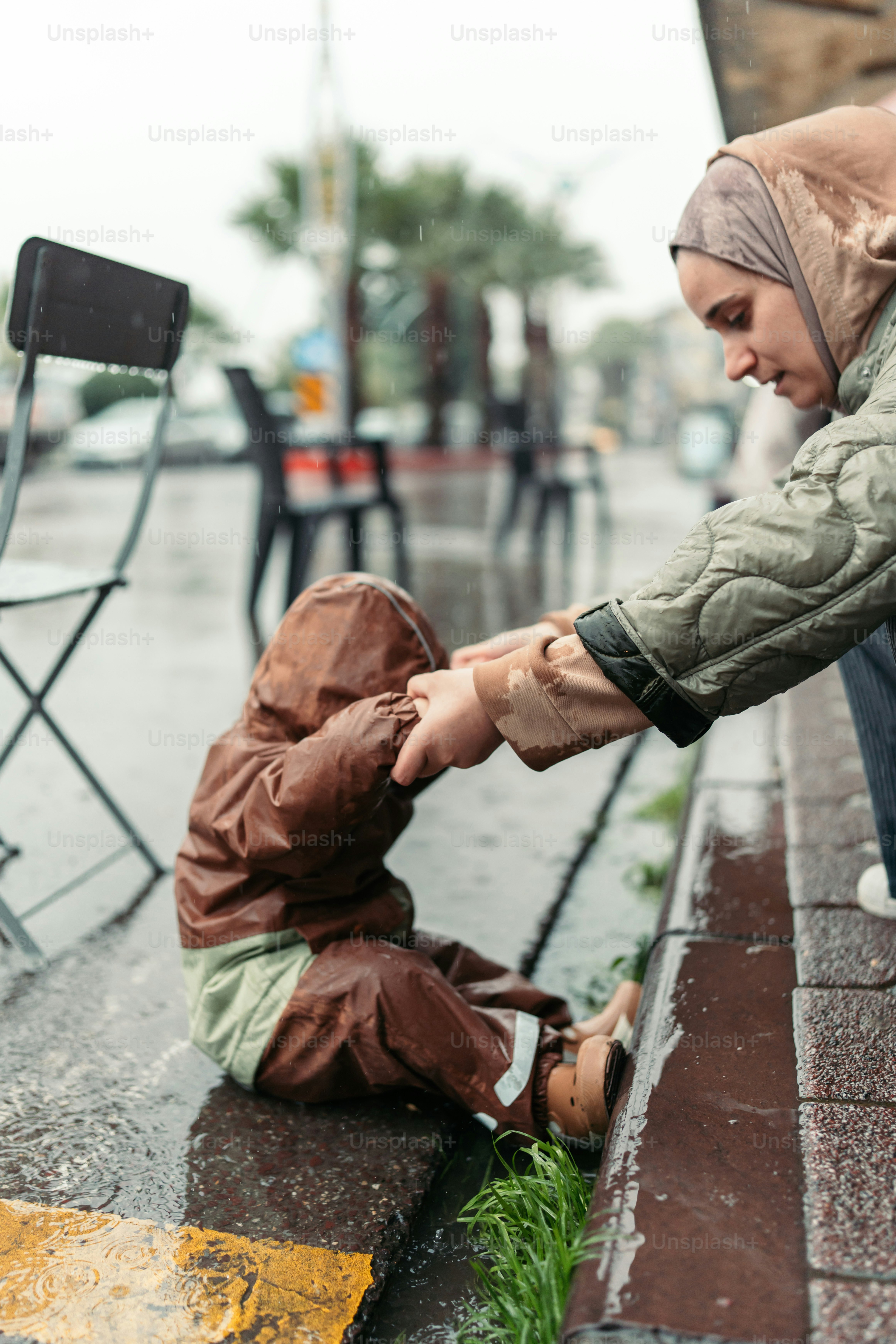 A woman handing something to a small child photo – Children playing ...