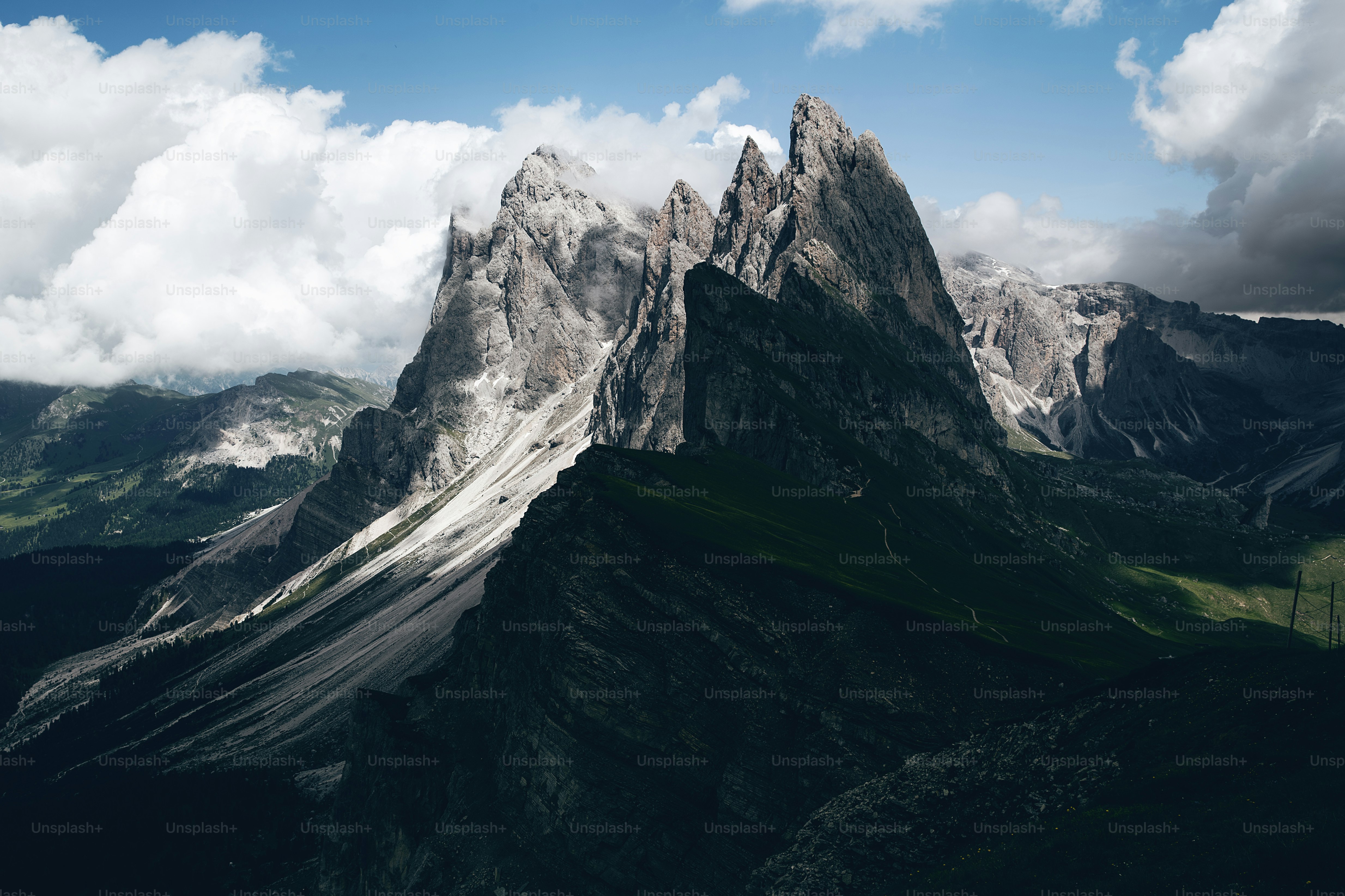 A very tall mountain with some clouds in the sky photo – Outdoors Image ...