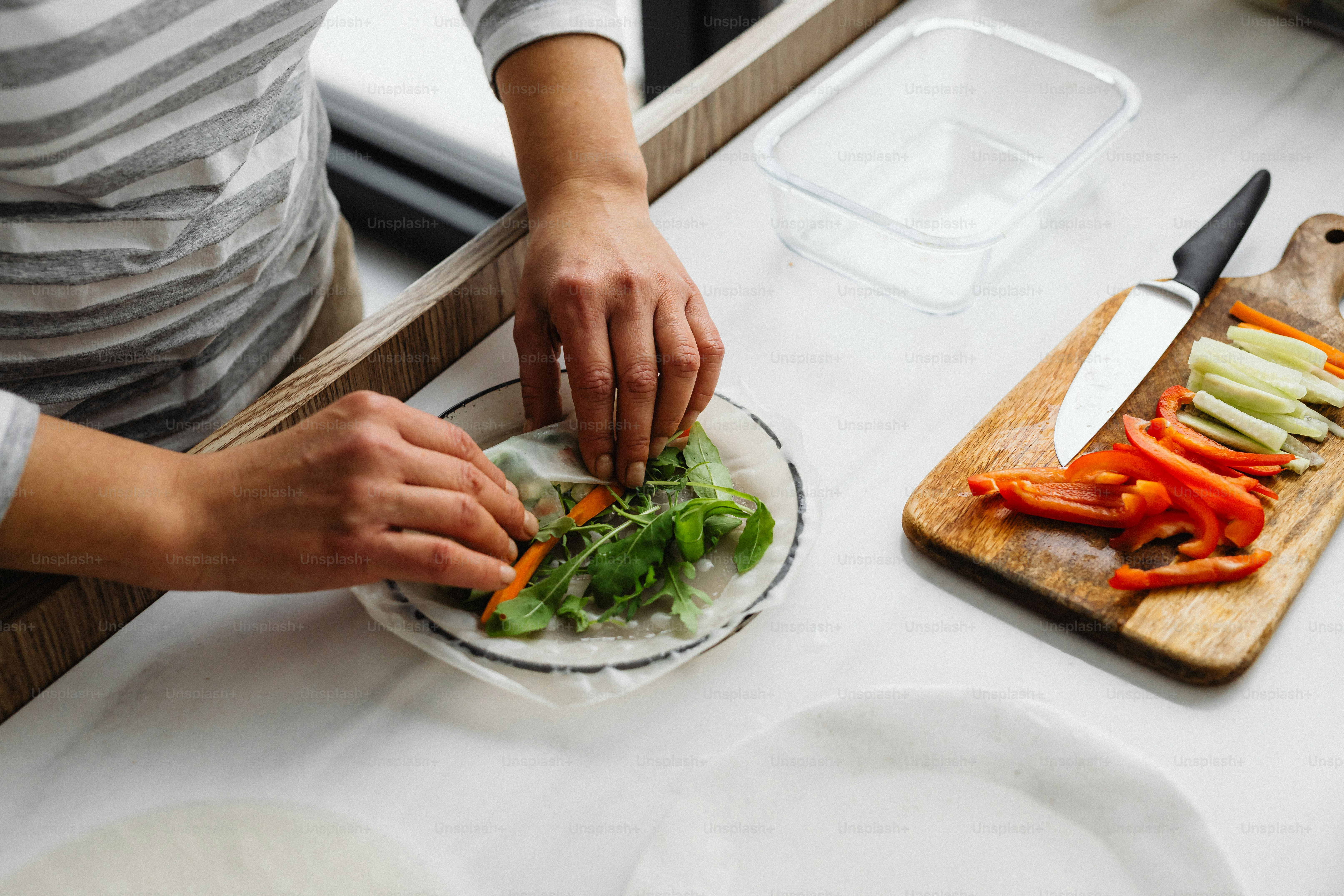 A person cutting vegetables on a cutting board photo – Meal prepping ...
