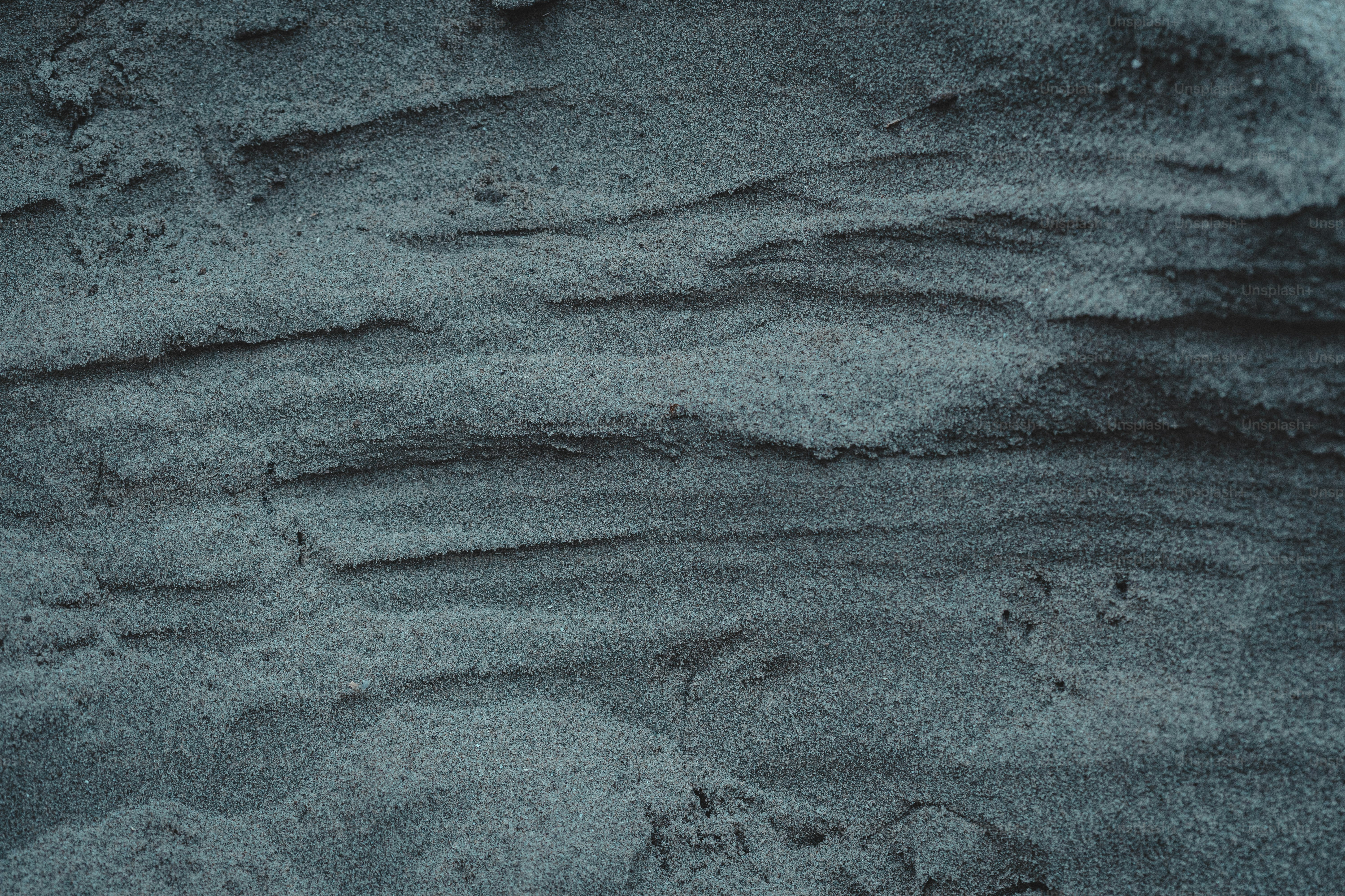 A close up of sand and water on a beach photo – Sand texture Image on ...